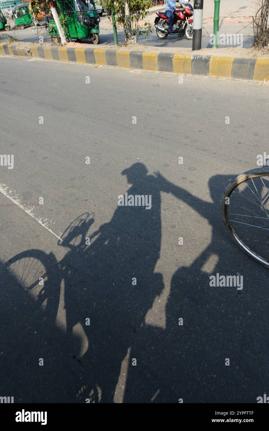 A shadow of a cycle rickshaw in Dhaka, Bangladesh Stock Photo - Alamy