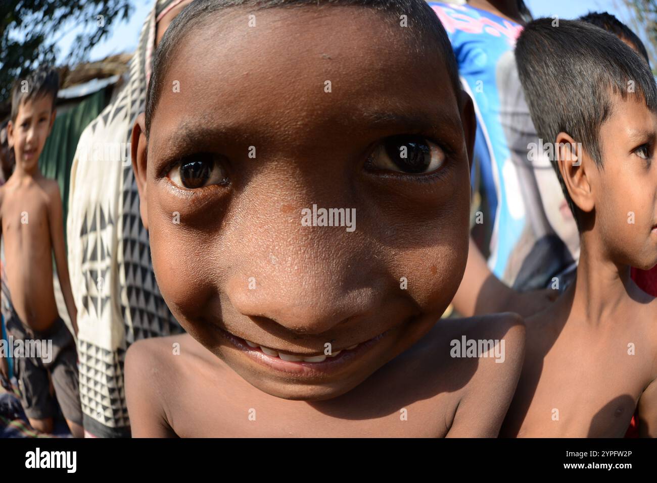 Bengali children having fun with the camera in a roadside slum in Dhaka ...