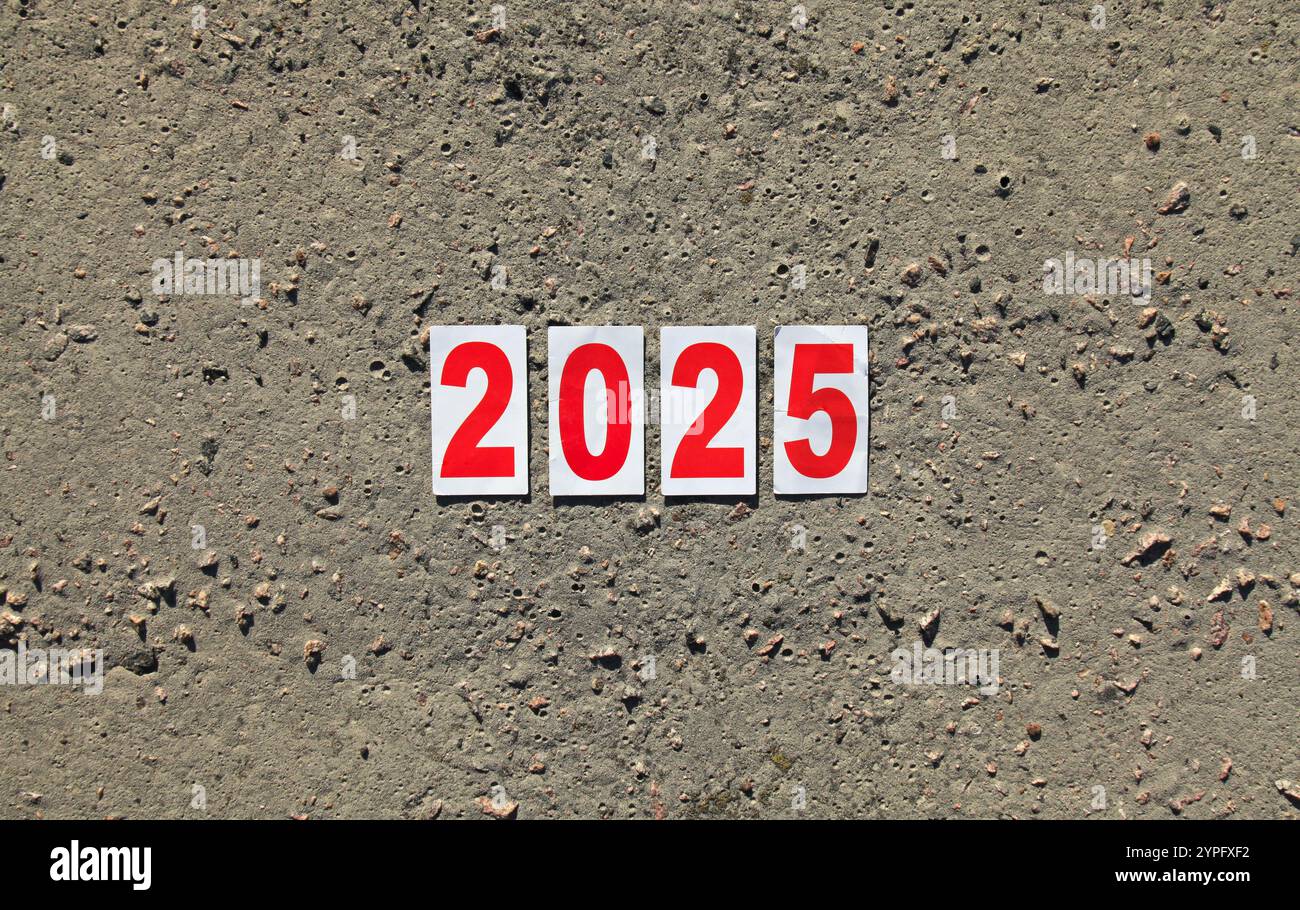 Numbers of 2025 year. Paper square numbers on the grey concrete ...