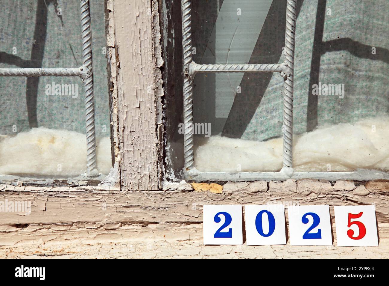 Numbers of 2025 year. Paper square numbers on the old wooden window ...