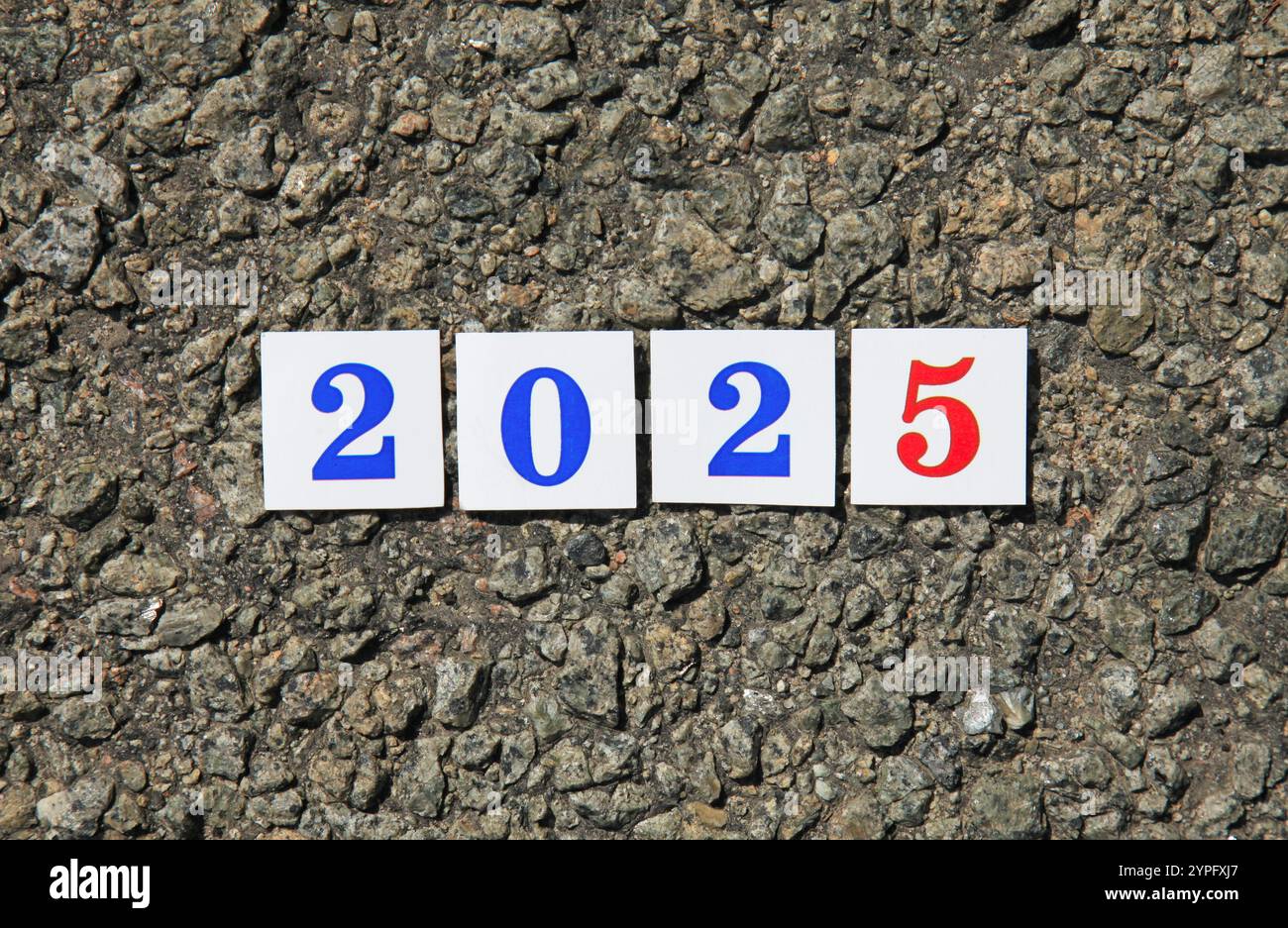 Numbers of 2025 year. Paper square numbers on the stone road background ...