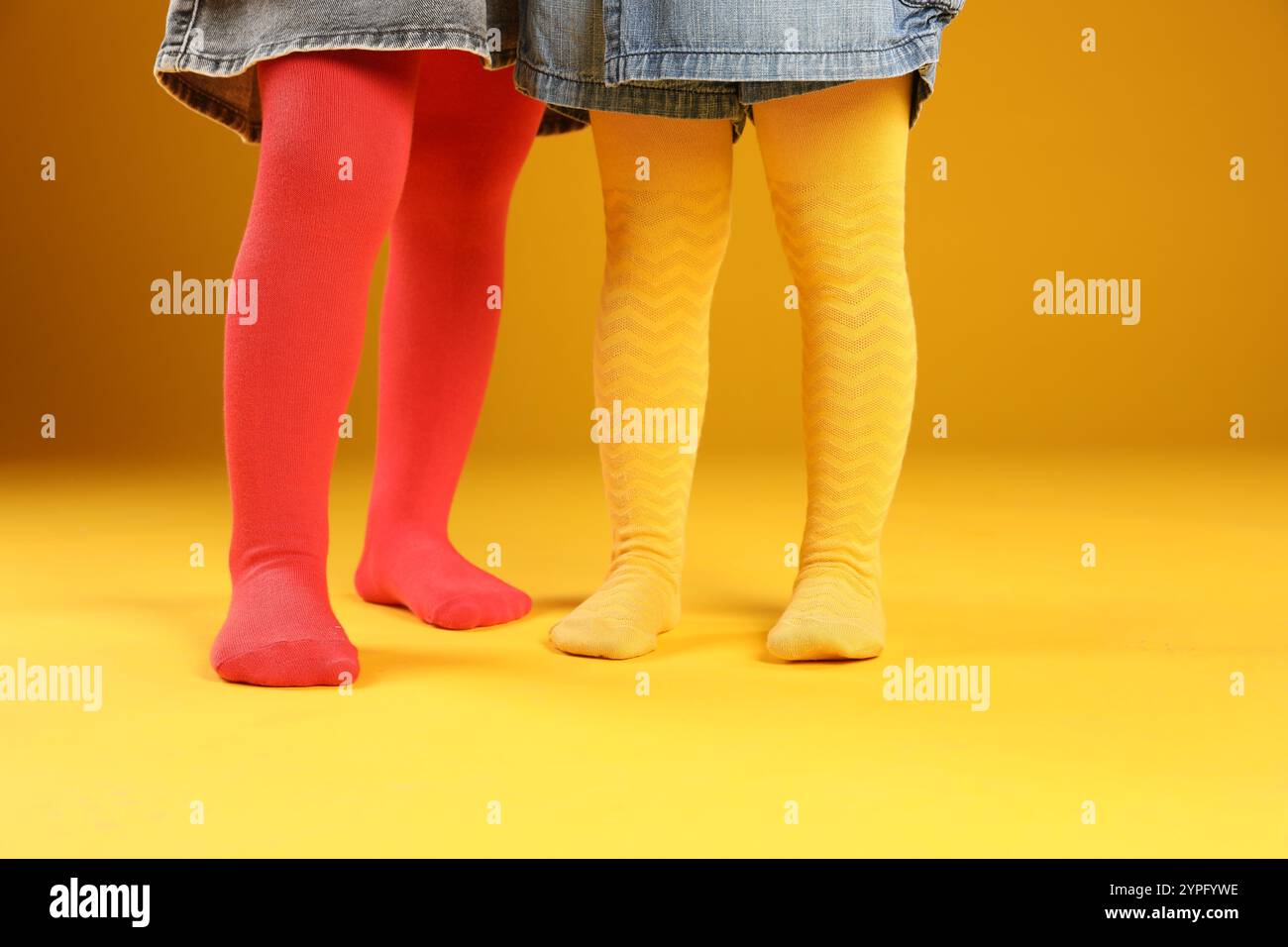 Kids wearing colorful tights on orange background, closeup Stock Photo ...