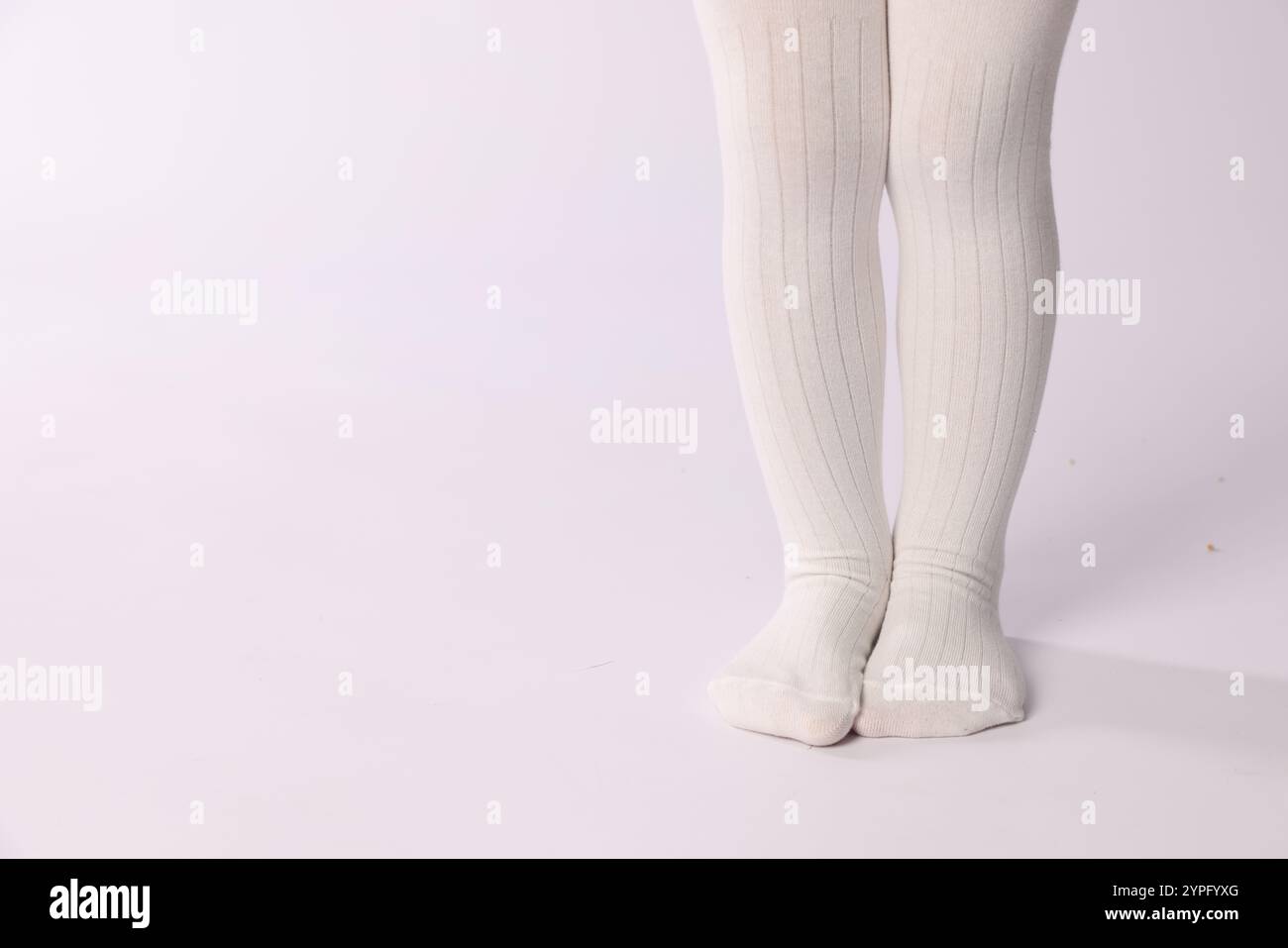 Child wearing tights on white background, closeup. Space for text Stock ...