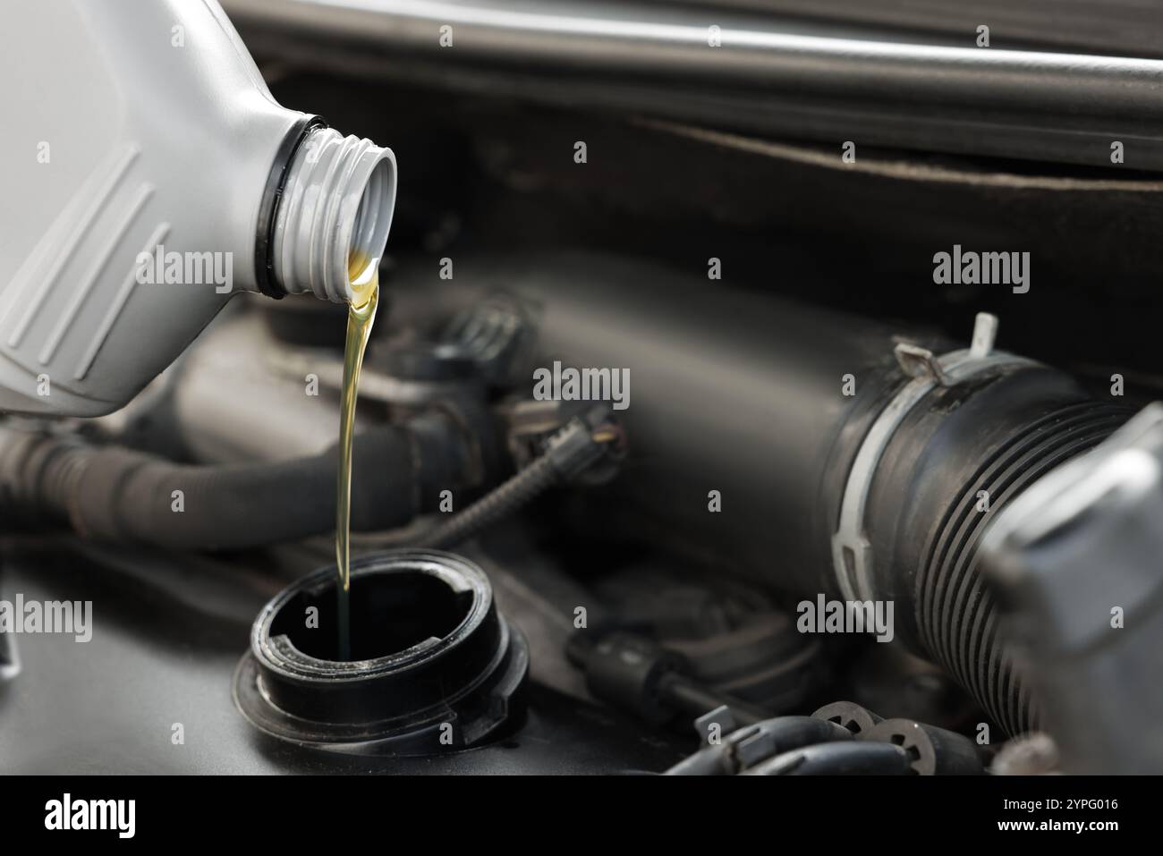 Closeup mechanic pouring motor hi-res stock photography and images - Alamy