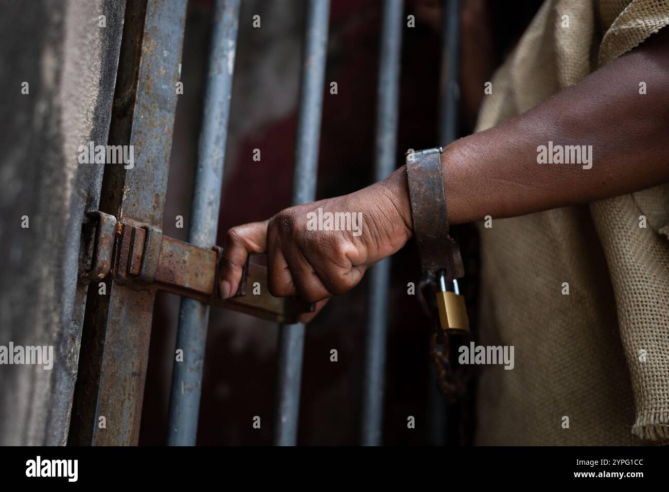 Black woman dressed as a slave, chained with an iron mask on her mouth ...