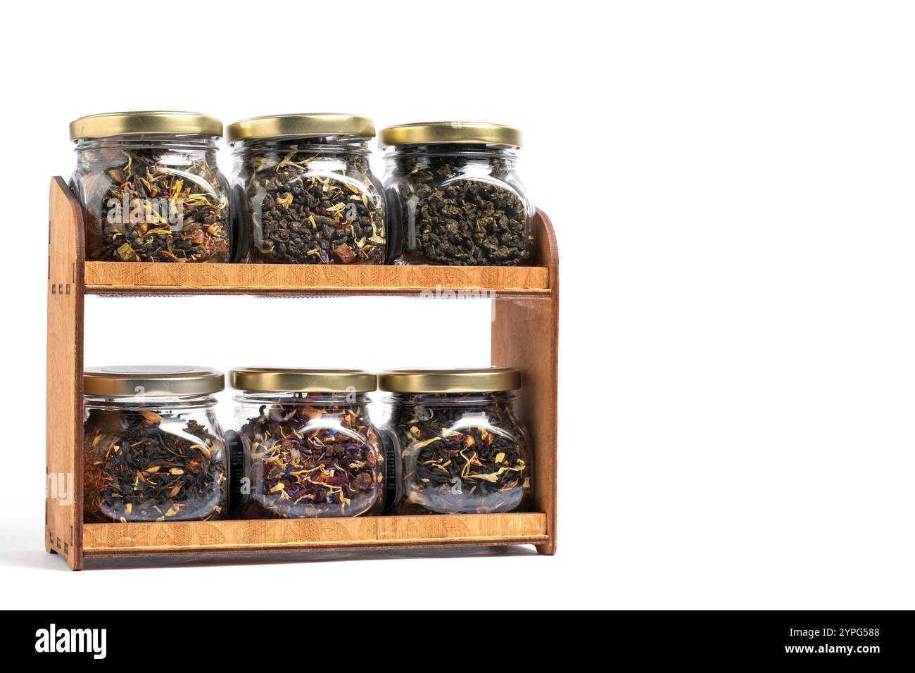 Jars on shelf with set teas different flavors. On white background ...