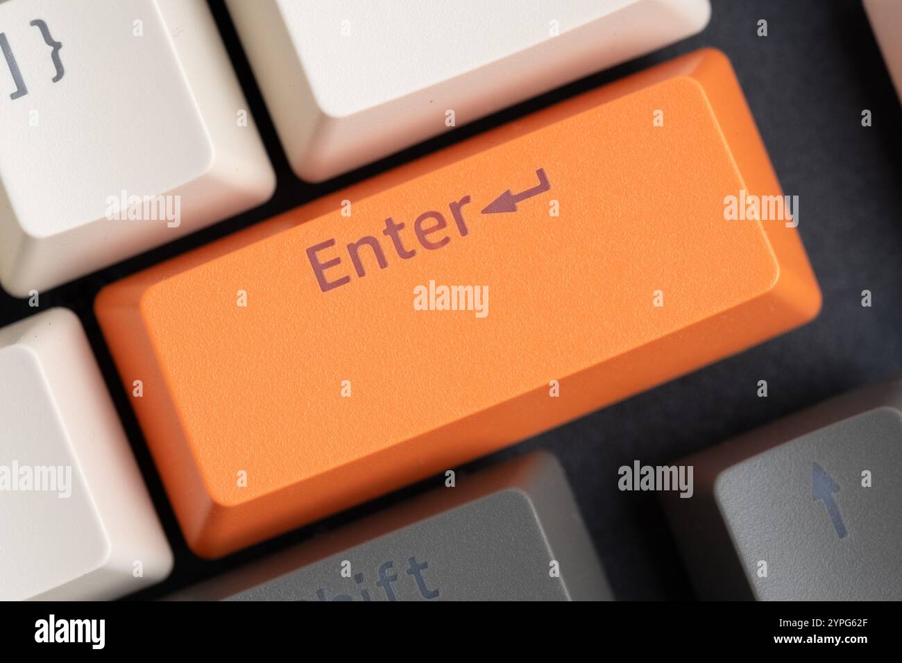Orange key with word enter on computer keyboard. Closeup Stock Photo ...