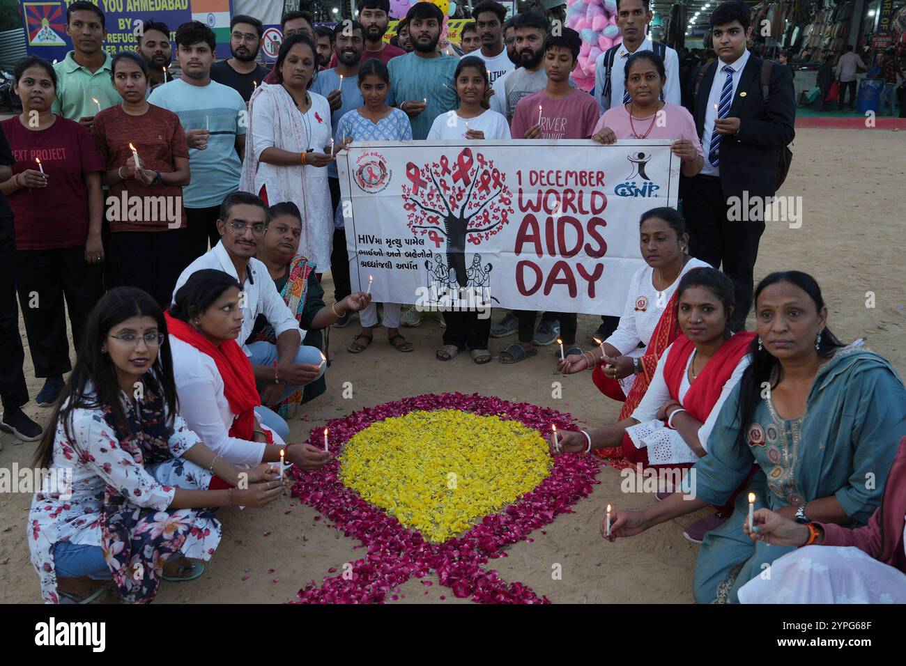 People and members of a Non Government Organization(NGO) hold candles ...