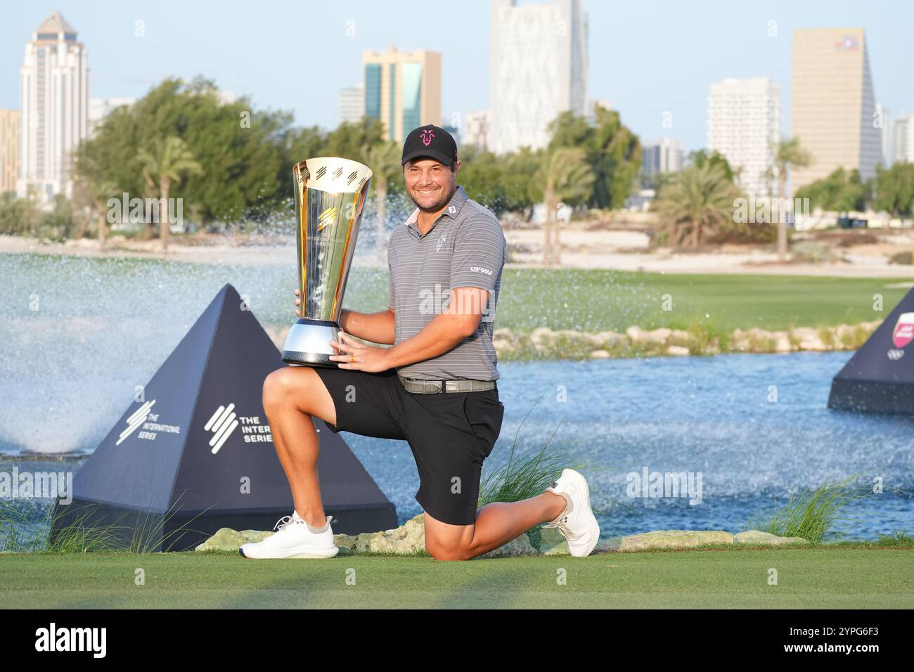 Peter Uihlein of US poses with the International Series Qatar trophy at ...