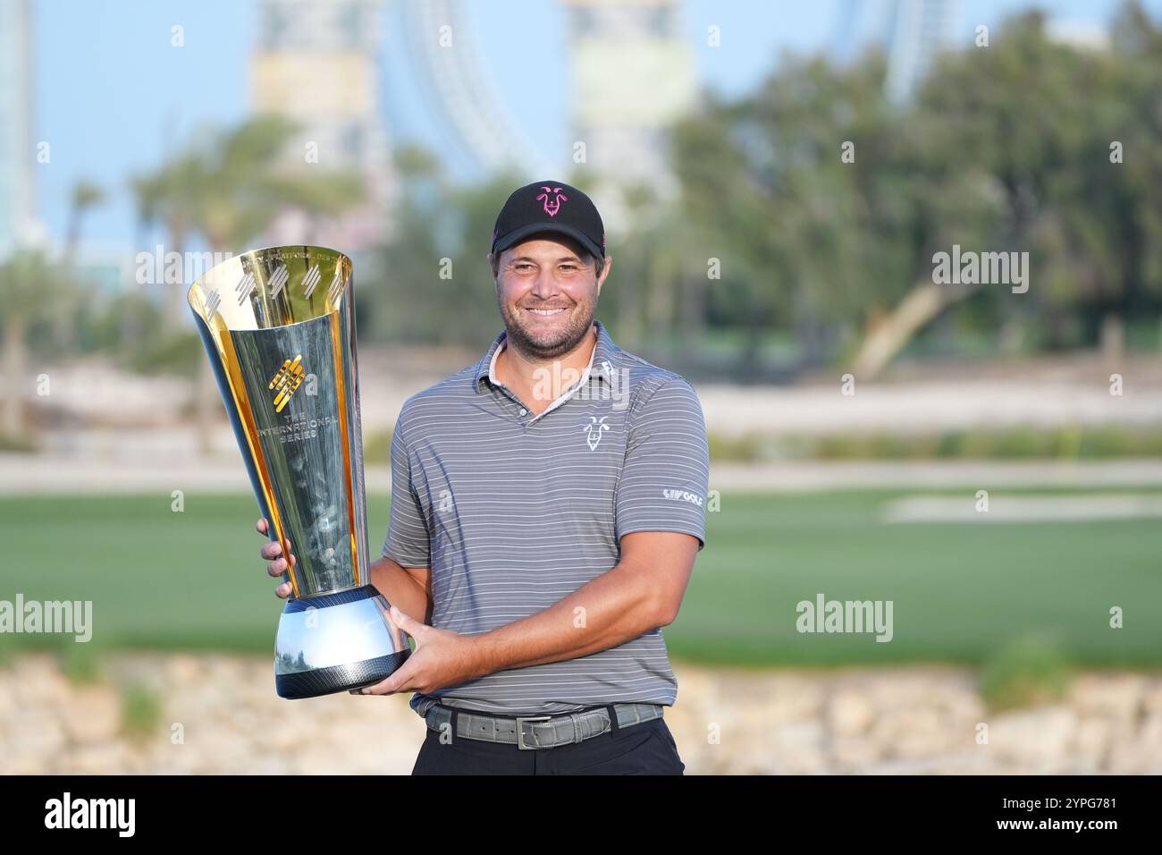 Peter Uihlein of US poses with the International Series Qatar trophy at ...