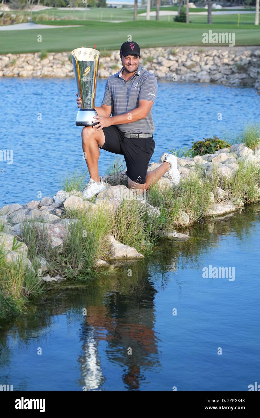 Peter Uihlein of US poses with the International Series Qatar trophy at ...