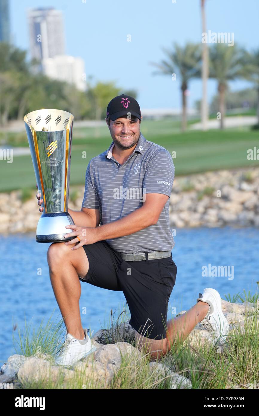 Peter Uihlein of US poses with the International Series Qatar trophy at ...