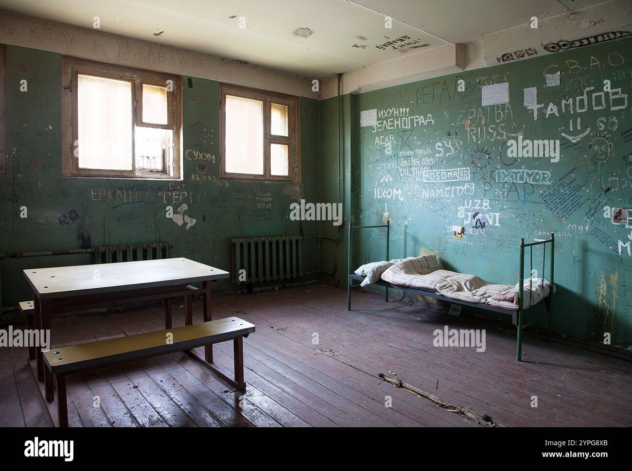 Dark prison cell with dirty walls and metal bad at abandoned ...