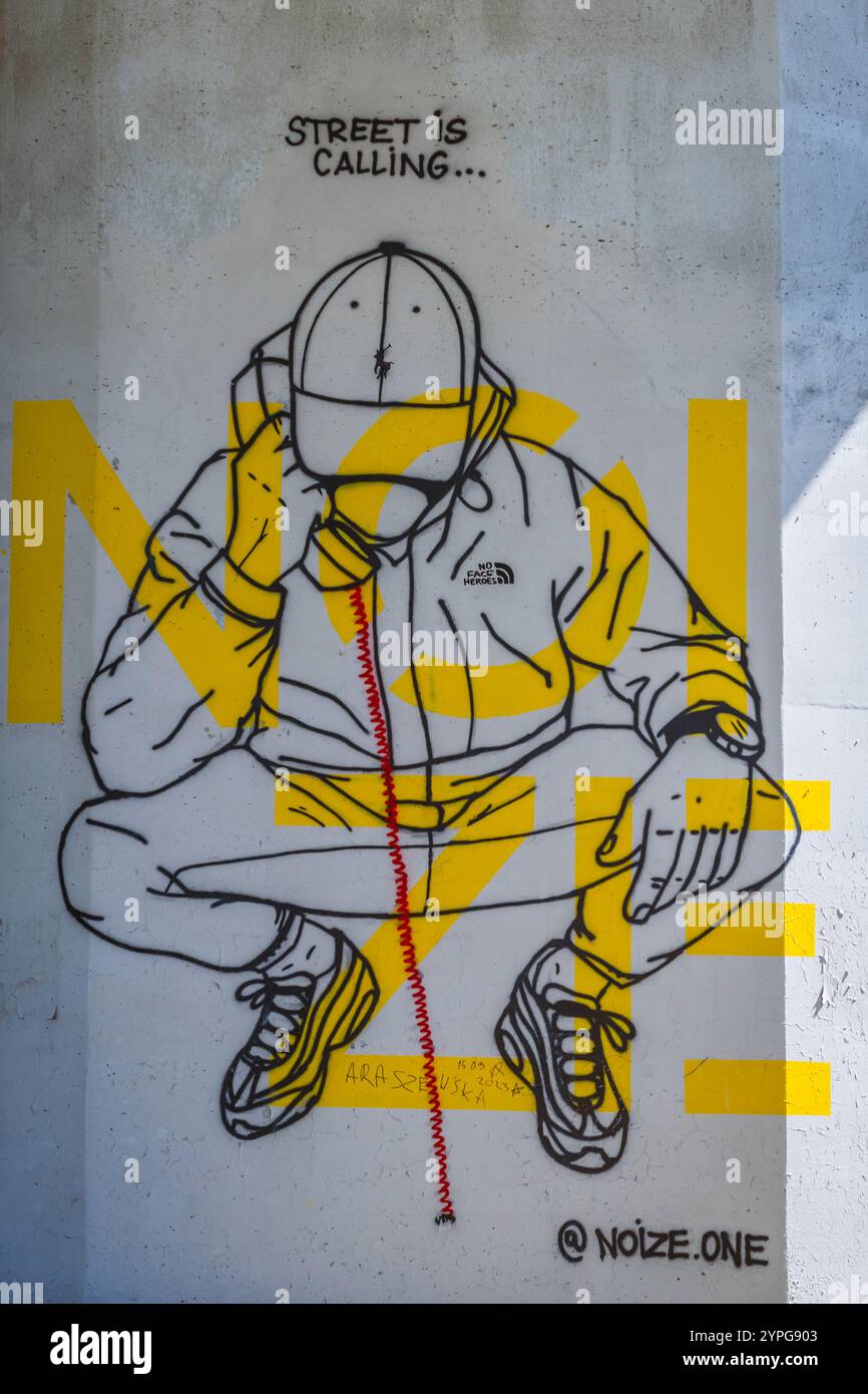 Grafitti mural depicting an outline of a man in a baseball cap making a ...