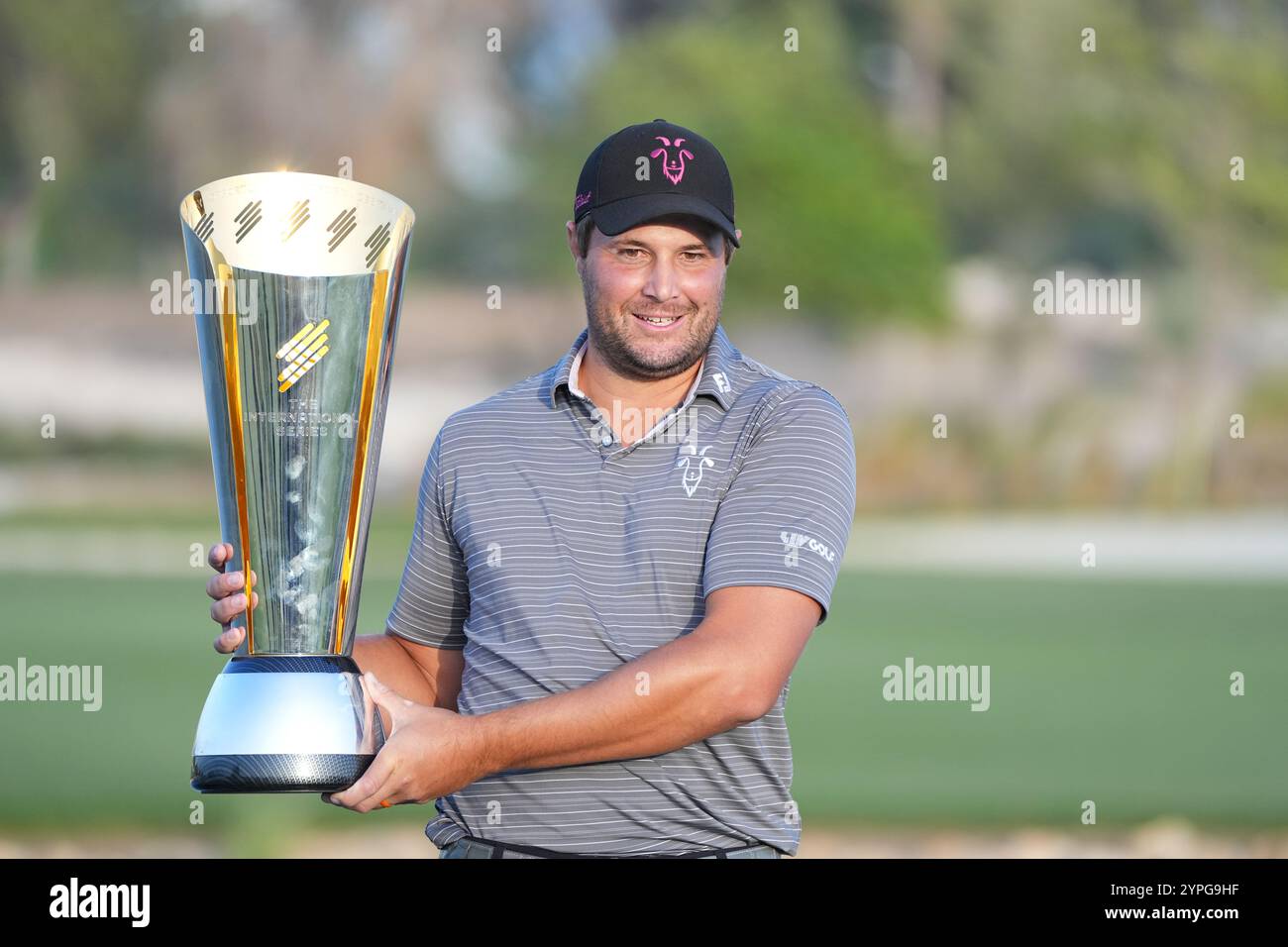 Peter Uihlein of US poses with the International Series Qatar trophy at ...