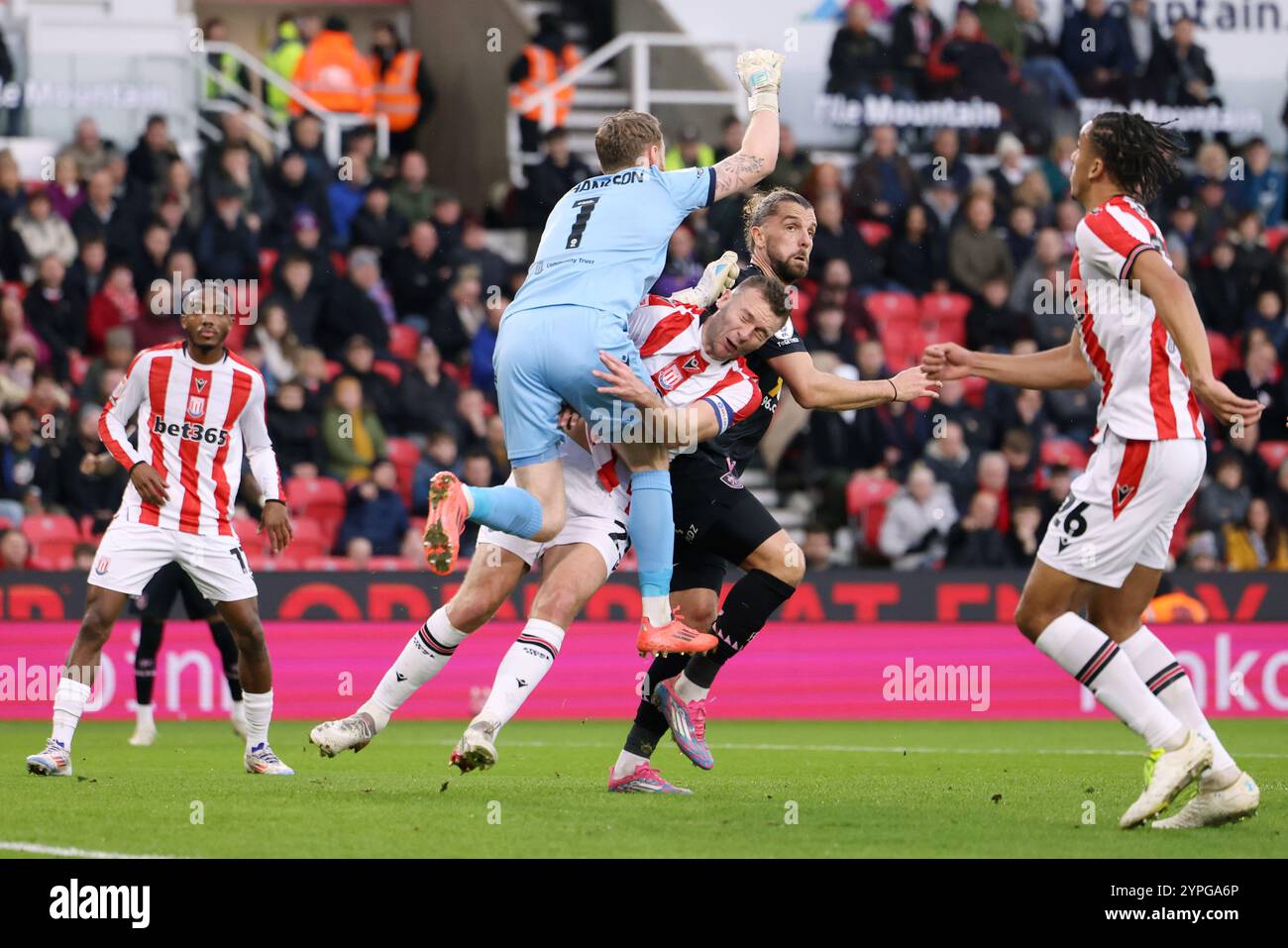 Stoke City's Ben Gibson (centre) collides with goalkeeper Viktor ...