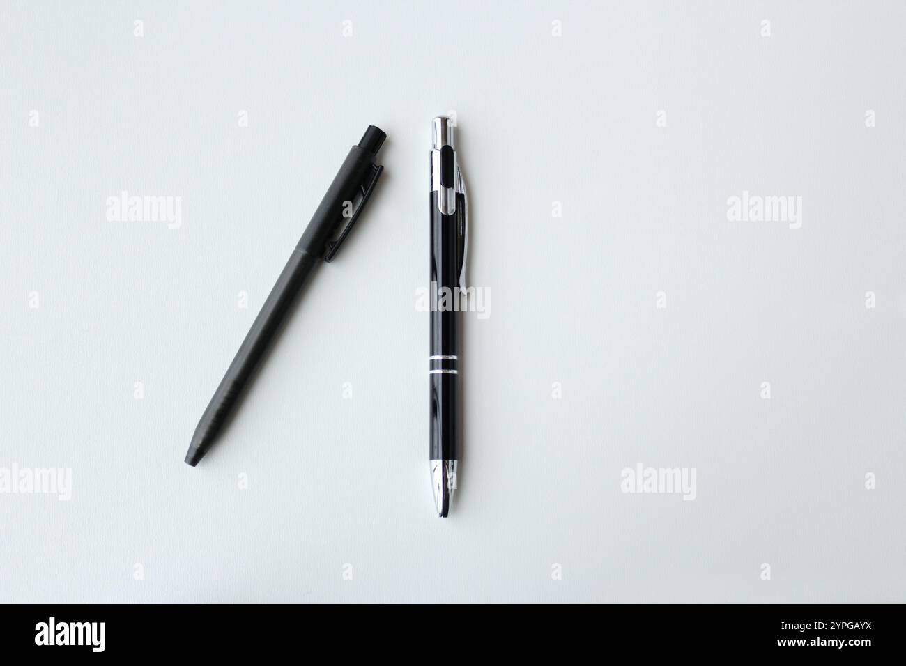 Two black pens isolated on white background with space for copy ...