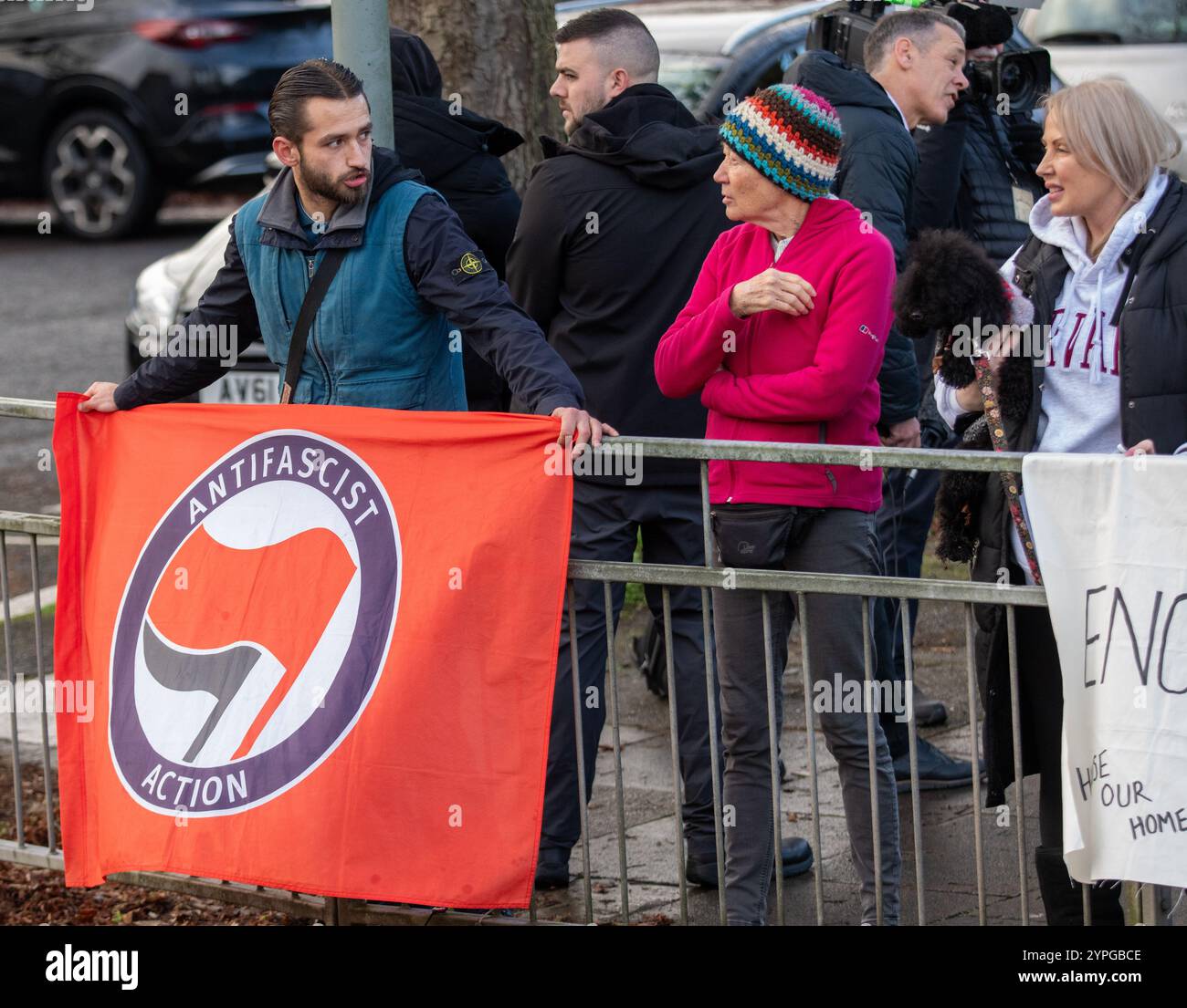Man unfolds an antifacist action flag next to Counter protest against ...