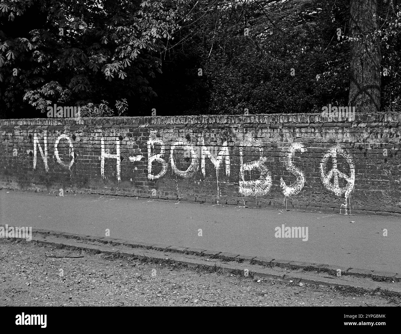 'NO H-BOMBS' painted on a brick wall ,together with the CND symbol ...