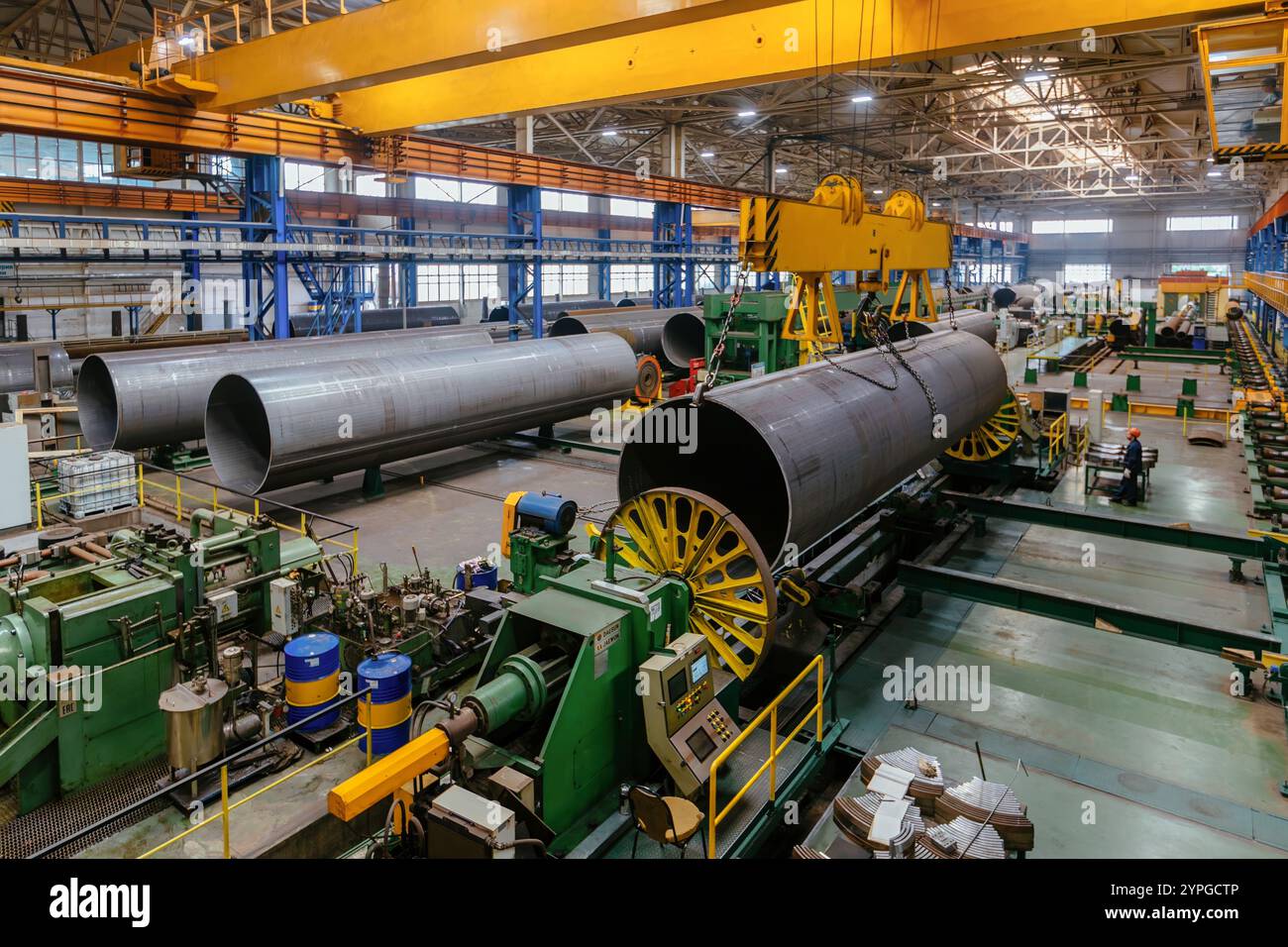 Steel pipe factory, working overhead crane Stock Photo - Alamy