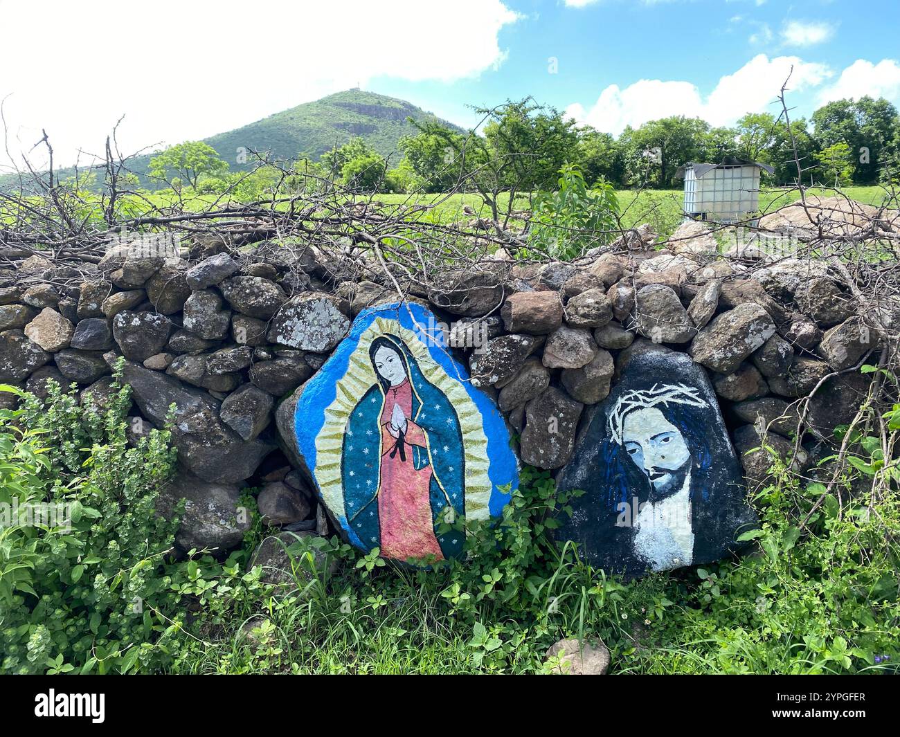 Two stones painted with the images of Jesus Christ and Our Lady of ...