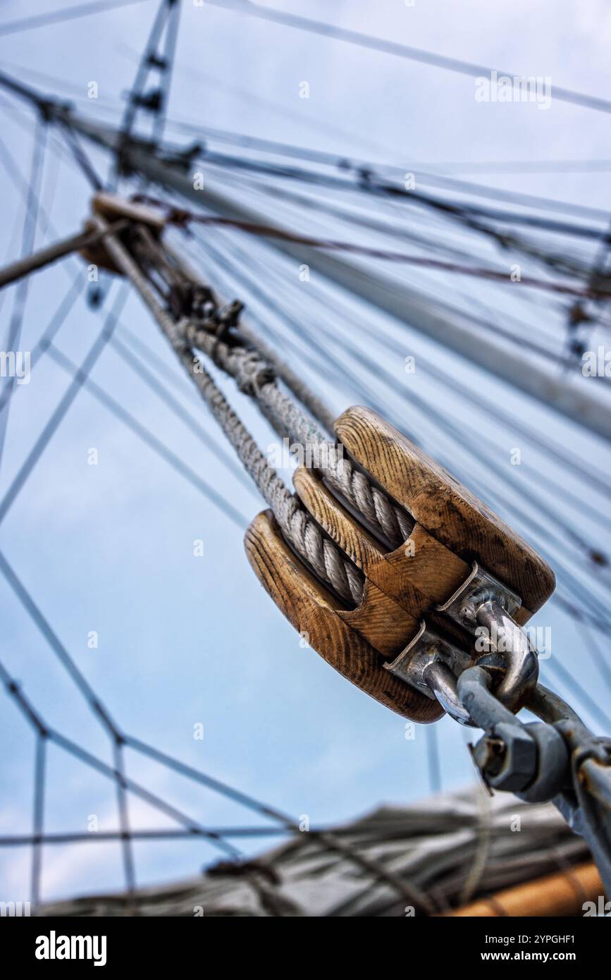 Large wooden sail pulley and ropes of a traditional sailing ship, with ...