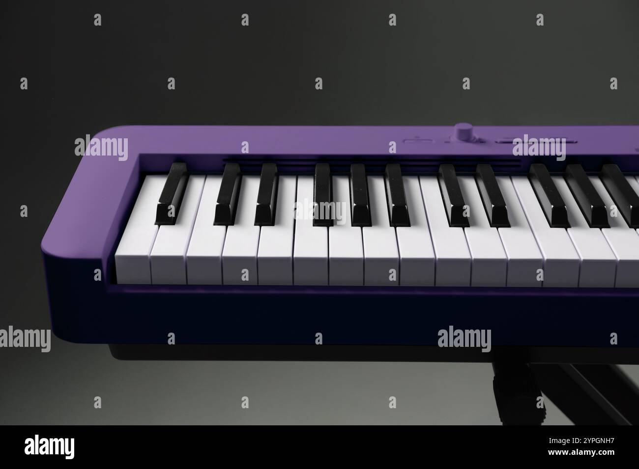 Purple synthesizer on dark background. Electronic musical instrument ...