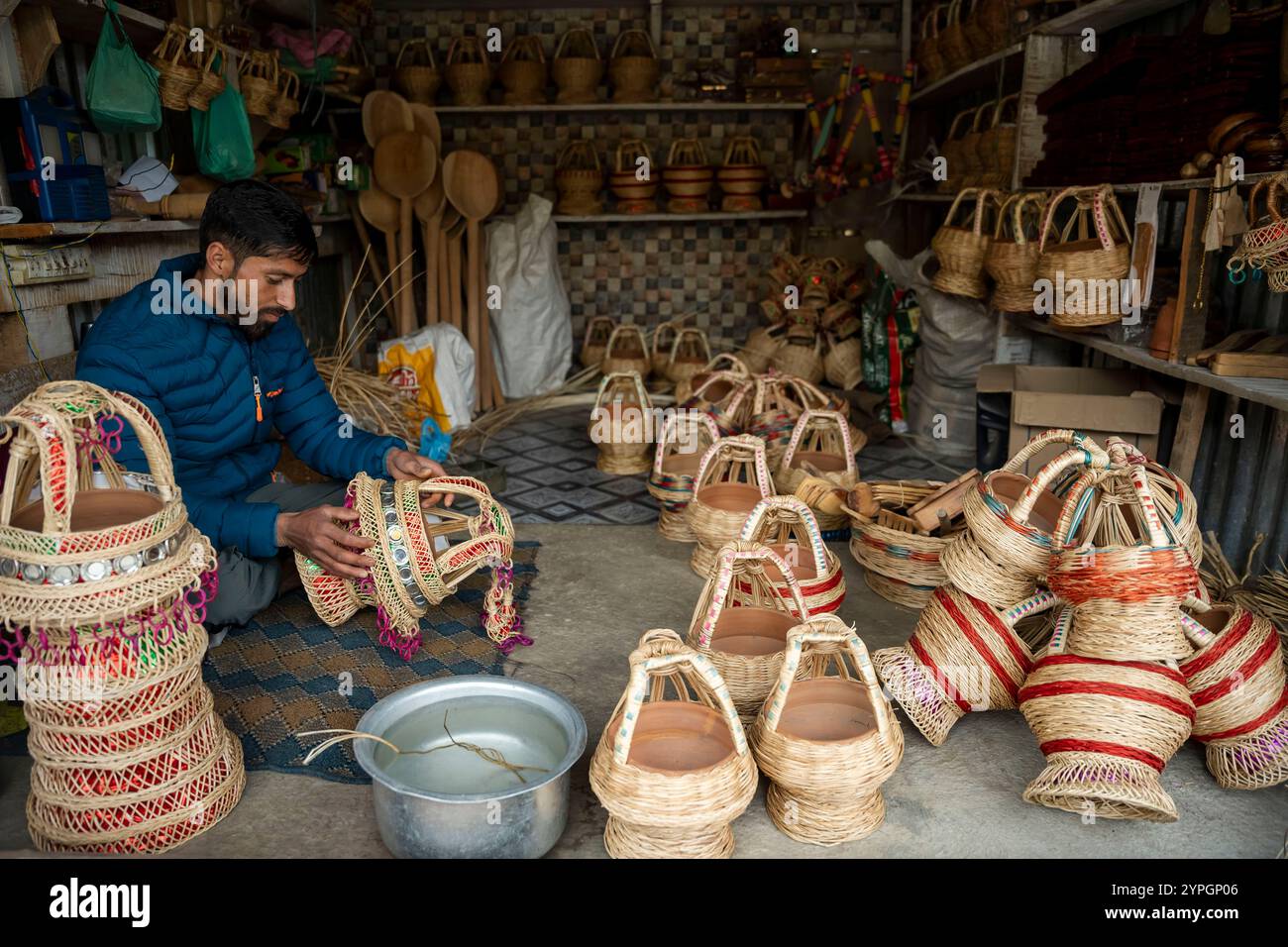 A Kashmiri man is seen his shop in Charar-i-Sharief town. In the biting ...