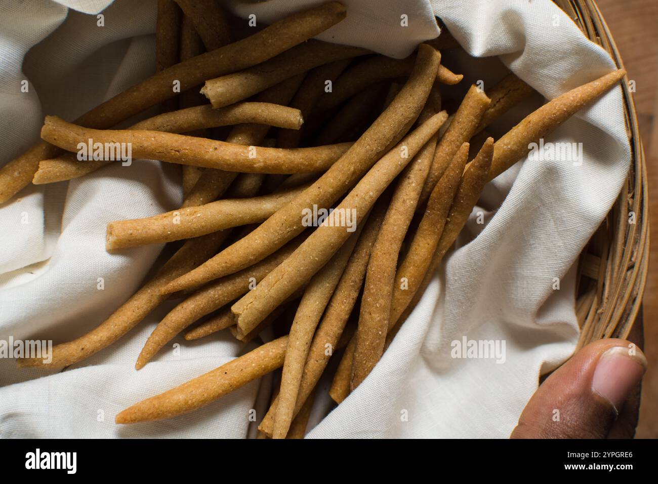 Top view of fried corn stick snack in a linen lined basket, Overhead ...