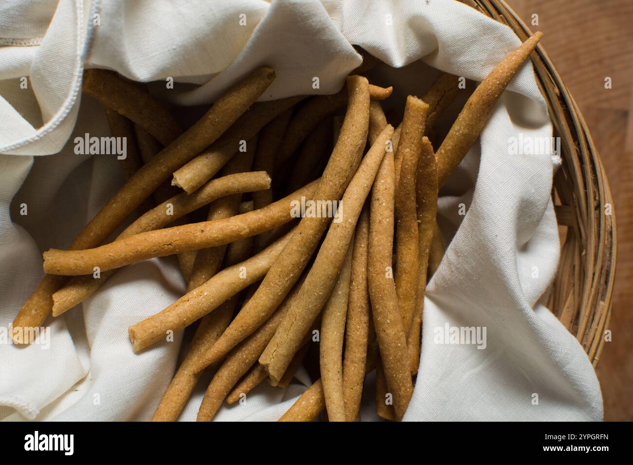 Top view of fried corn stick snack in a linen lined basket, Overhead ...