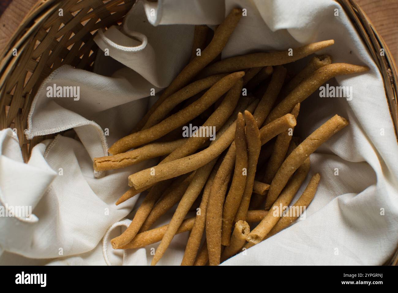 Top view of fried corn stick snack in a linen lined basket, Overhead ...