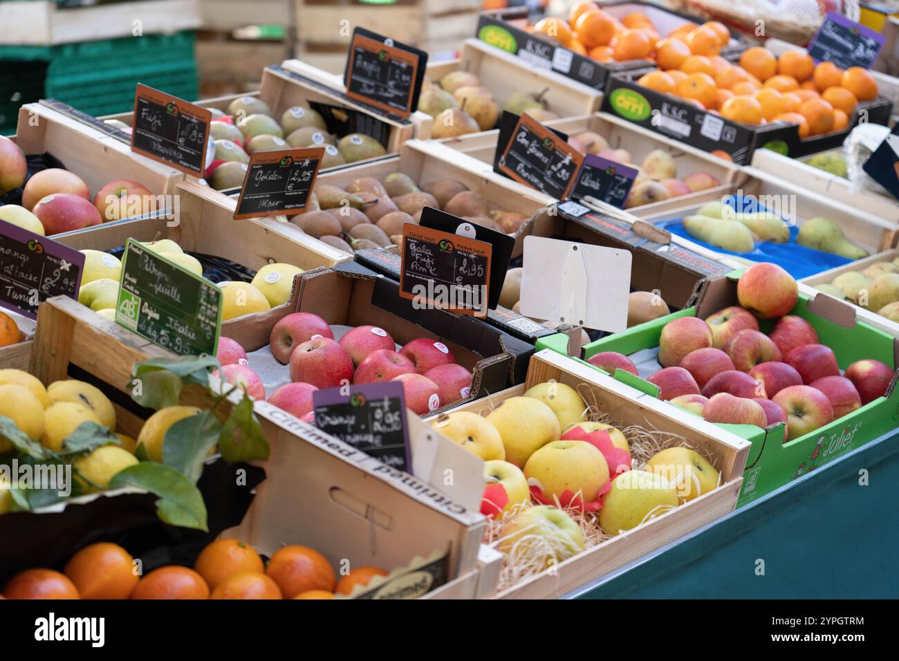 Colorful variety of fresh fruits displayed at a local market stall ...