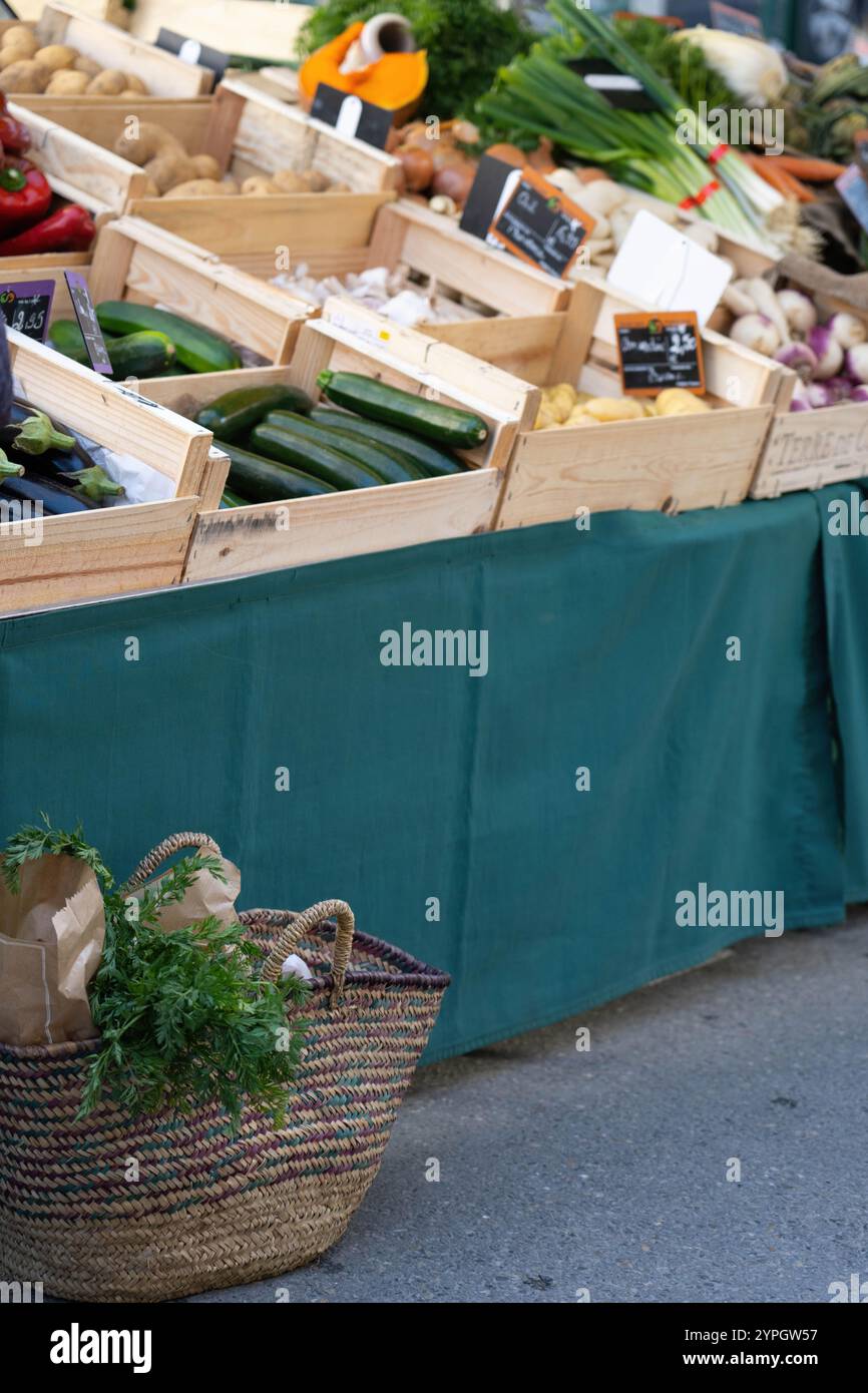 Fresh vegetables displayed at outdoor market stall with variety of ...