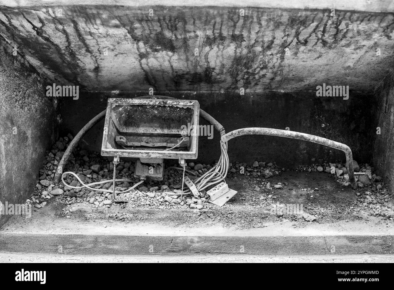 Destroyed and abandoned spotlight in a niche of a fallen wall after the ...