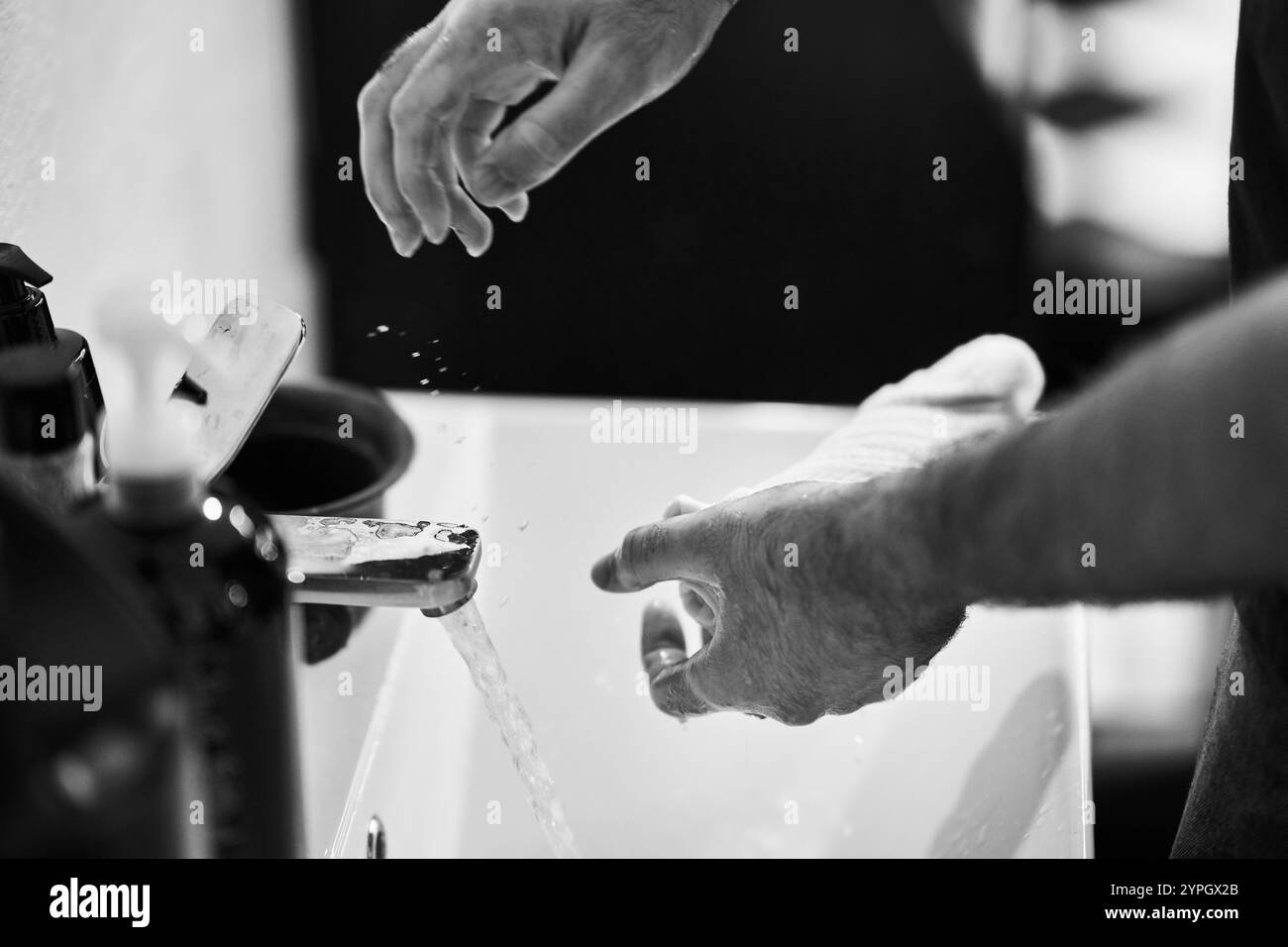 Hands washing with water at a sink in a simple setting Stock Photo - Alamy