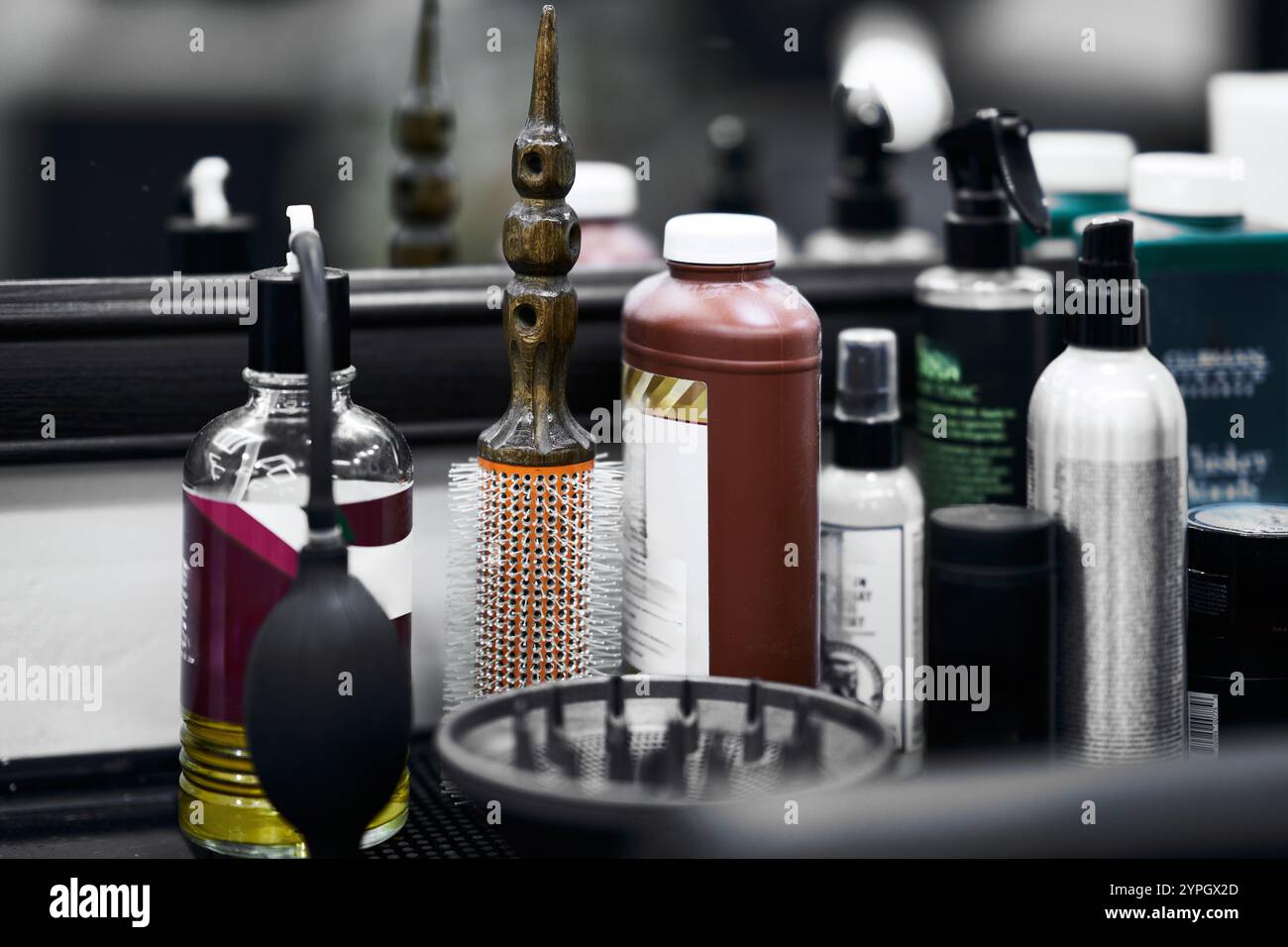 Collection of hair styling and grooming products in a salon countertop ...