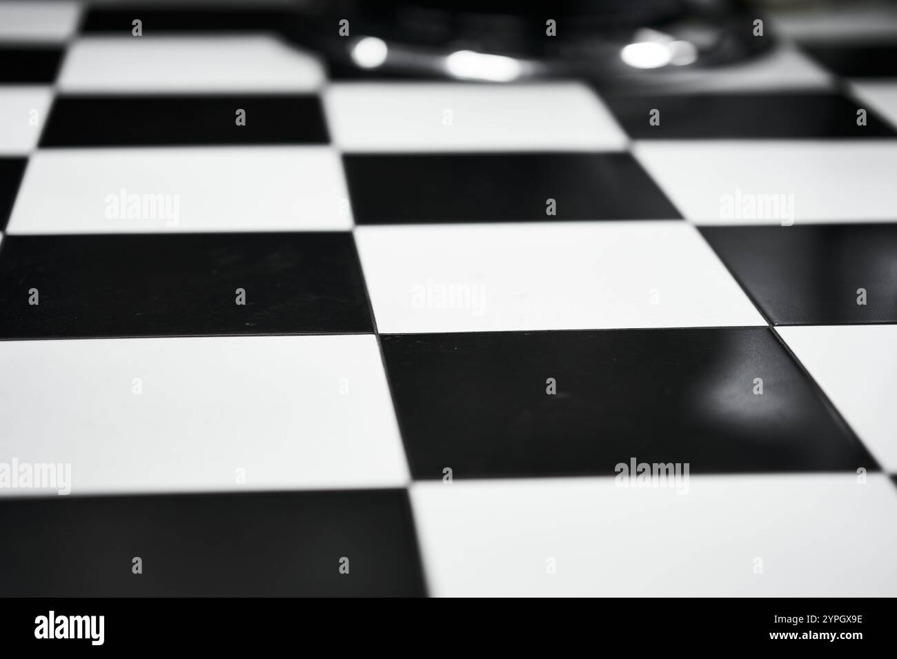 Black and white checkerboard pattern displayed on a polished surface ...