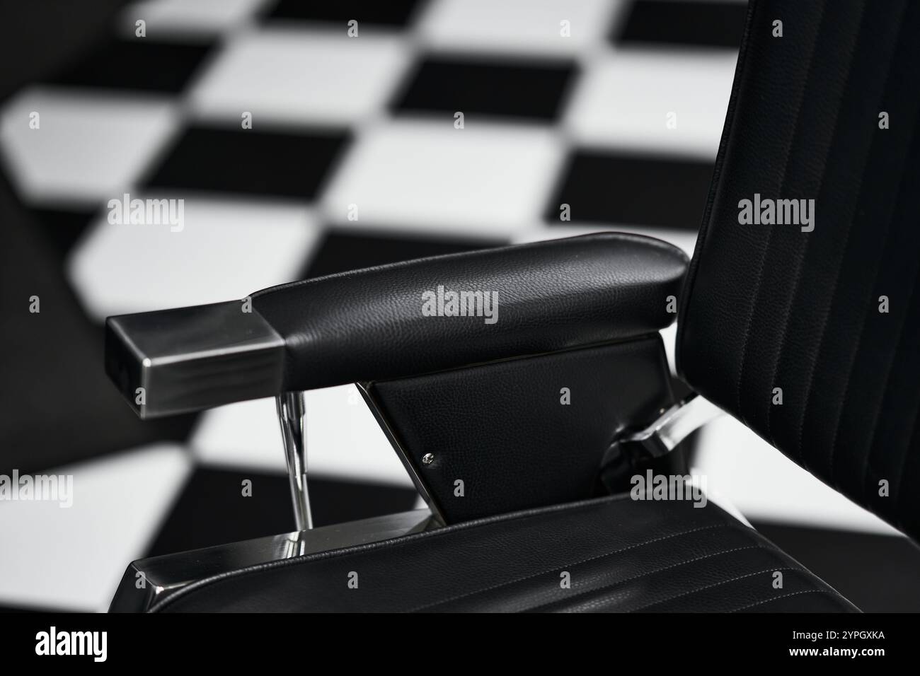 Black and white checkered floor with a modern barber chair at a salon ...