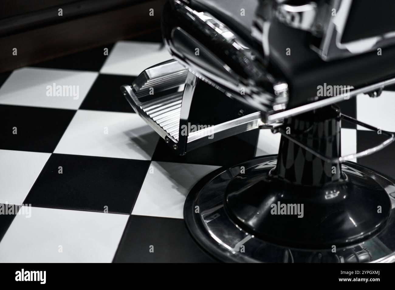 Classic barber chair on a black and white checkered floor Stock Photo ...