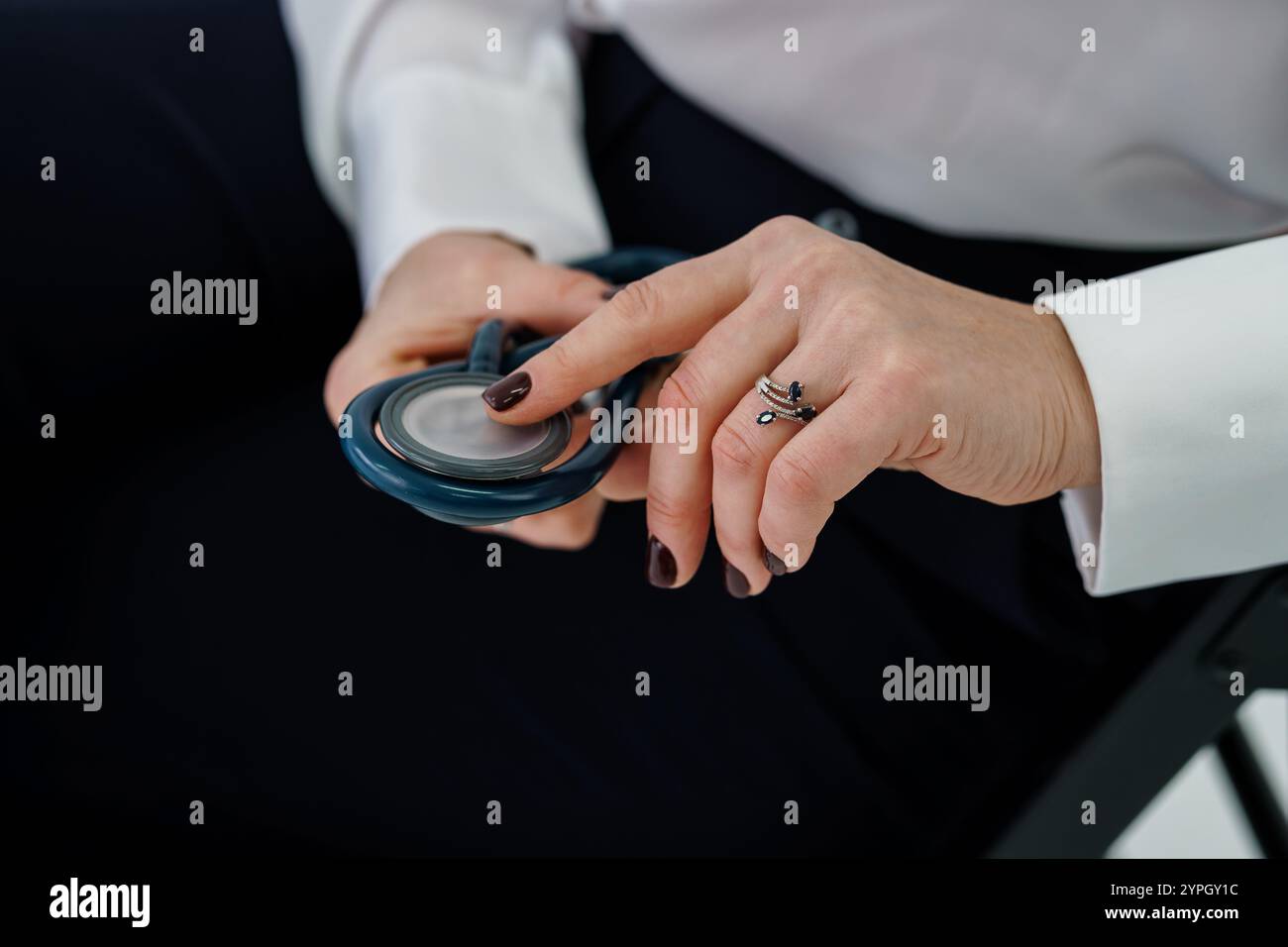 Doctor Preparing to Use Stethoscope in a Clinical Setting Stock Photo ...