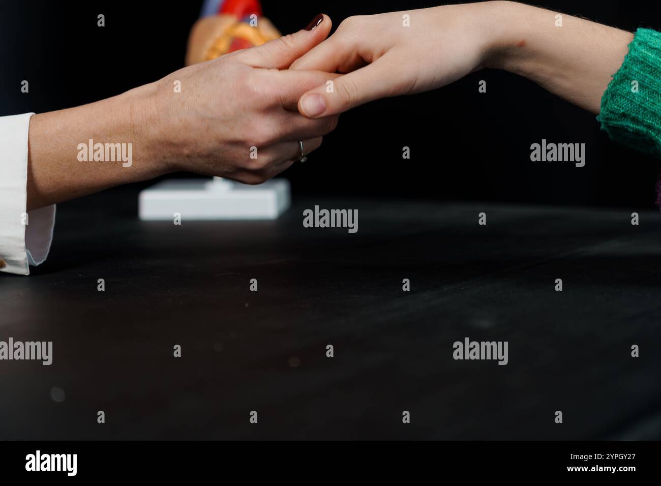 Intimate Connection: Two Hands Engaging in a Compassionate Touch Over a ...