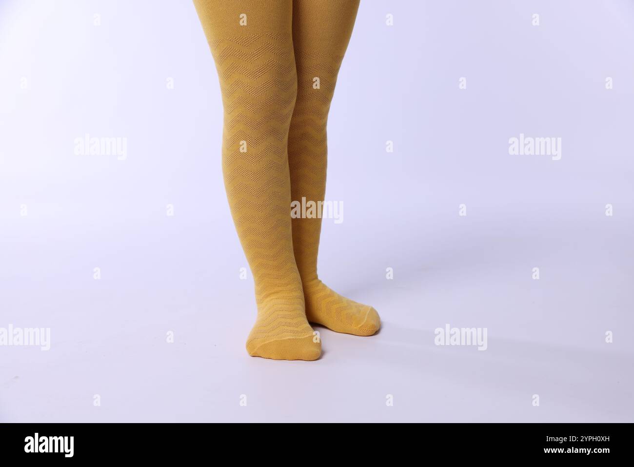 Child wearing bright tights on white background, closeup Stock Photo ...