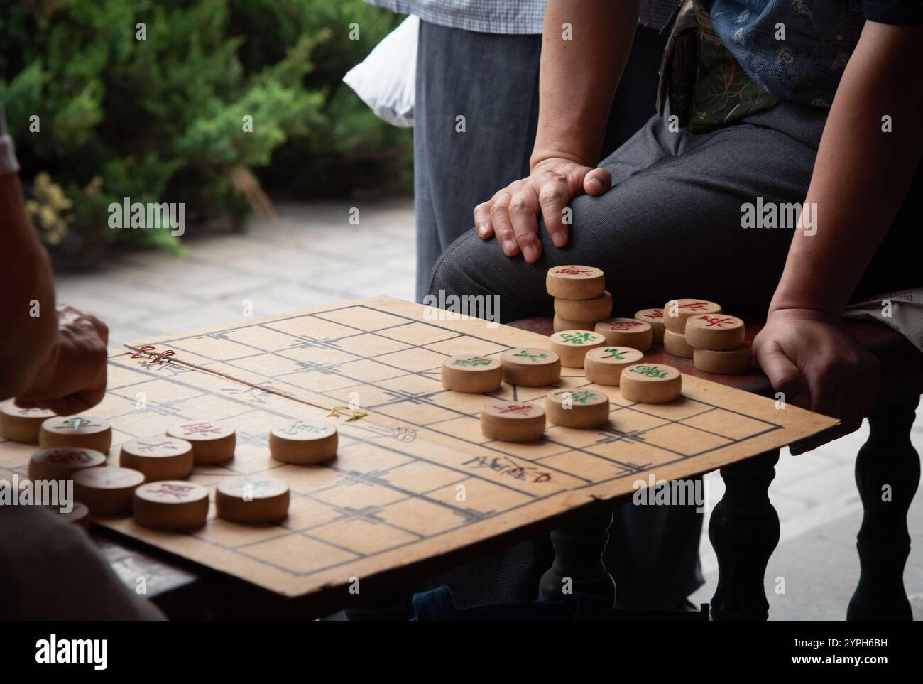 Two people are concentrating while playing a game of xiangqi, also ...