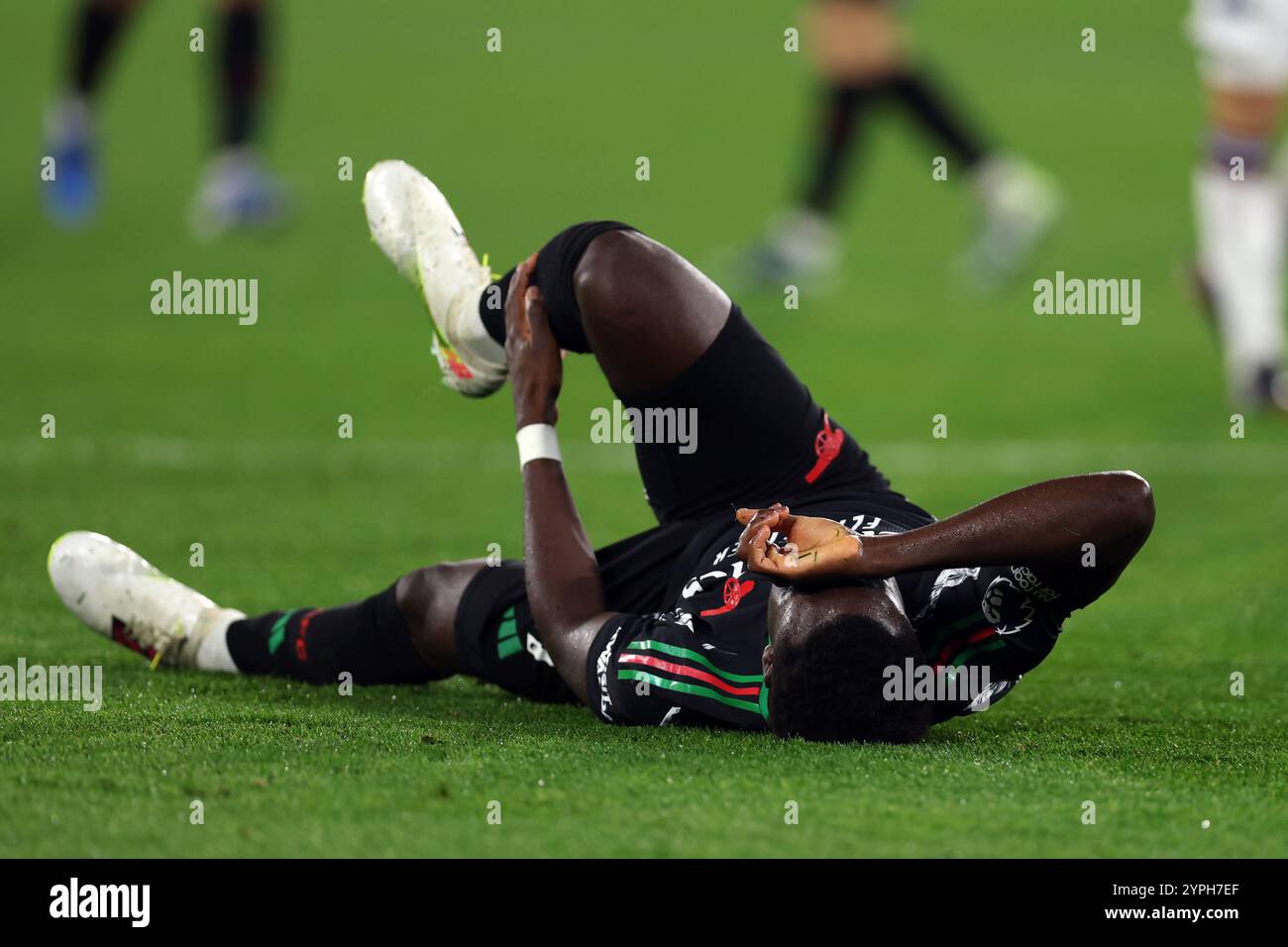 Arsenal's Bukayo Saka on the floor holding his leg during the Premier ...