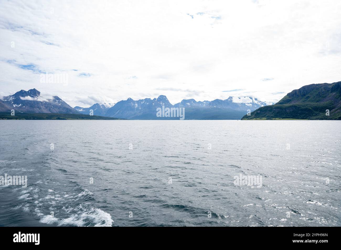 Green mountains, fjord and blue sky in Norwegian landscape in Svensby ...