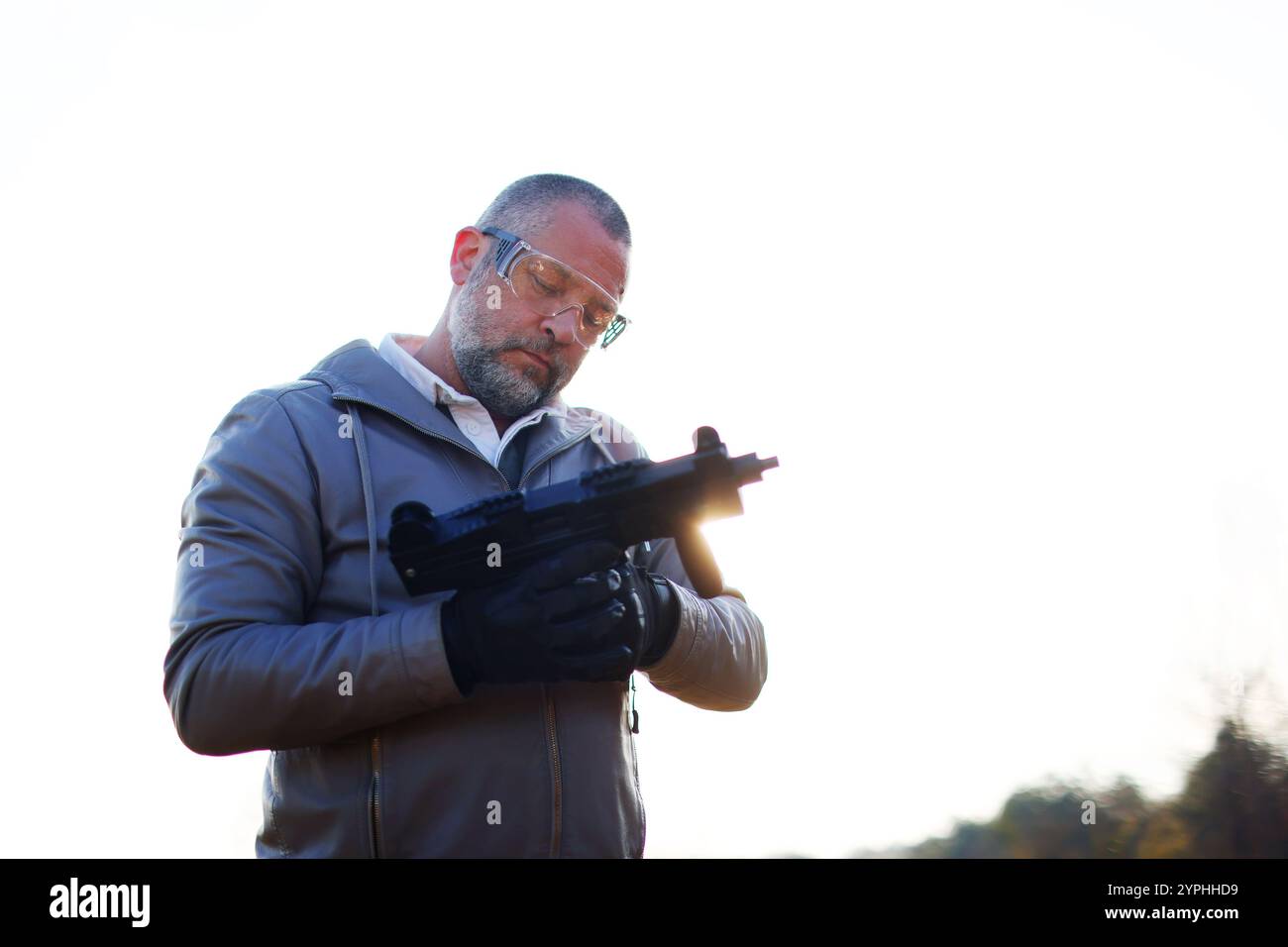 Man with gray jacket shooting black rifle on a white background Stock ...