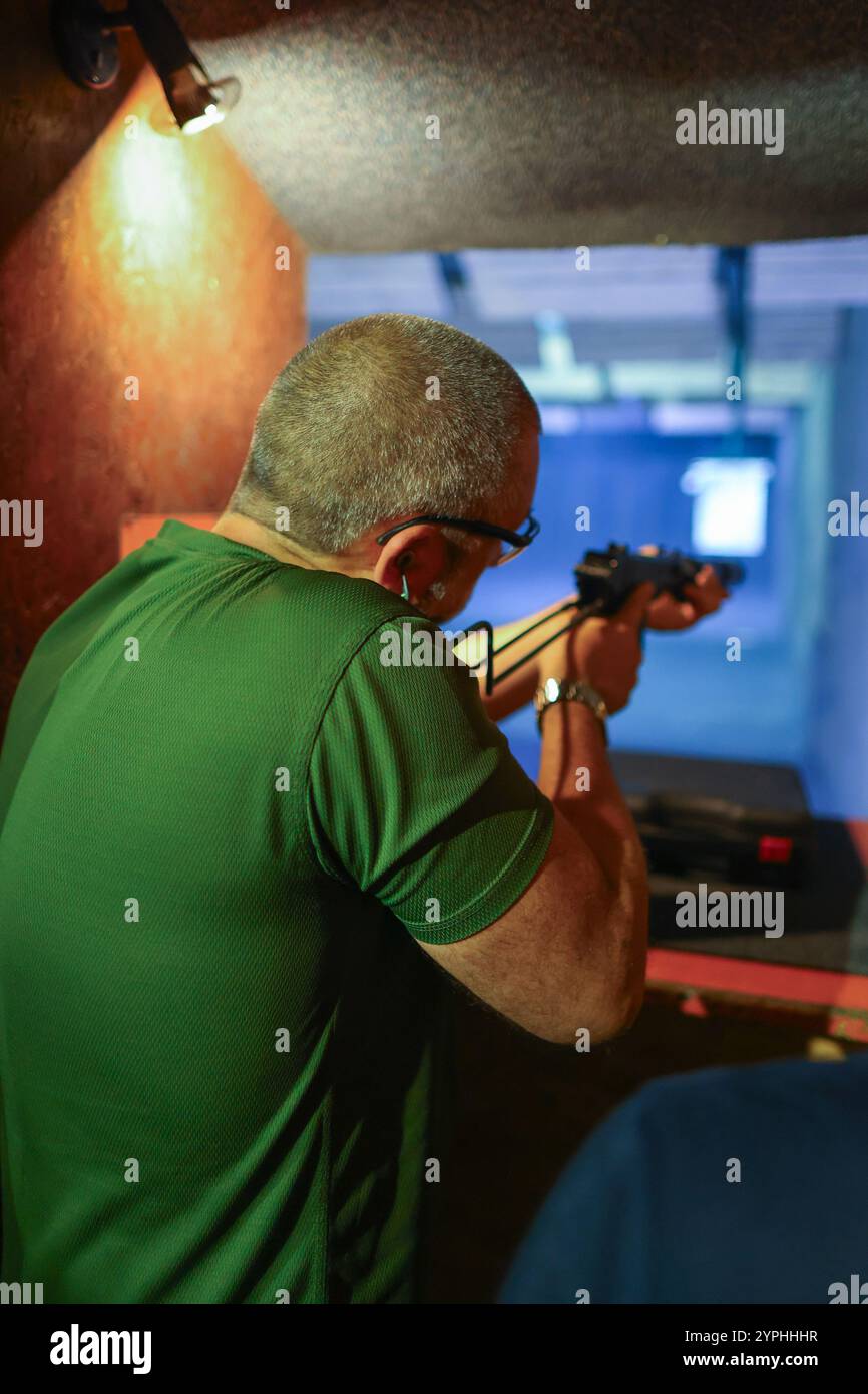 Shooting in the dash of short-barreled weapons. A man aims at a target ...