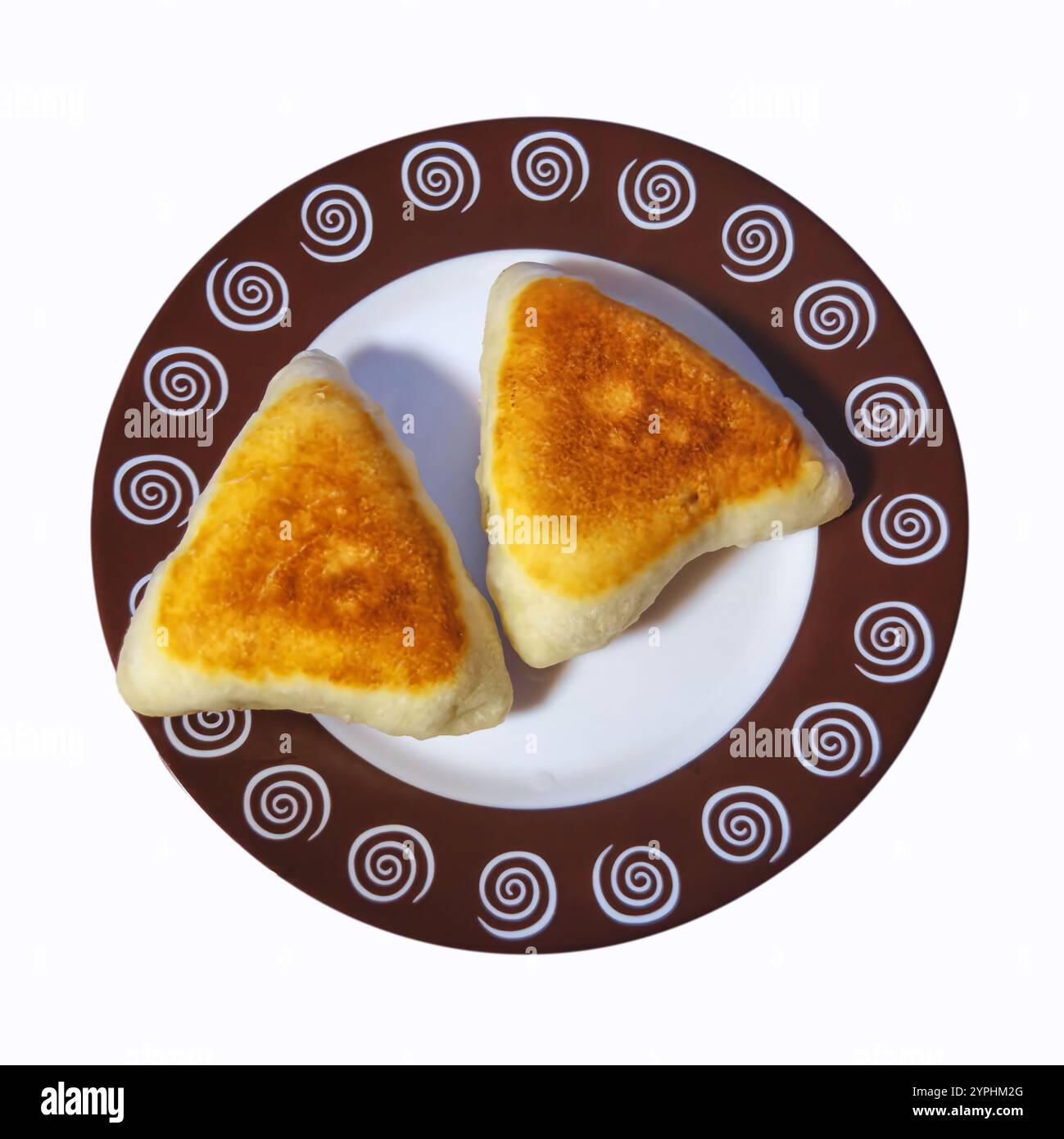 Triangular fried pies with chicken meat and onions on a platter isolate ...