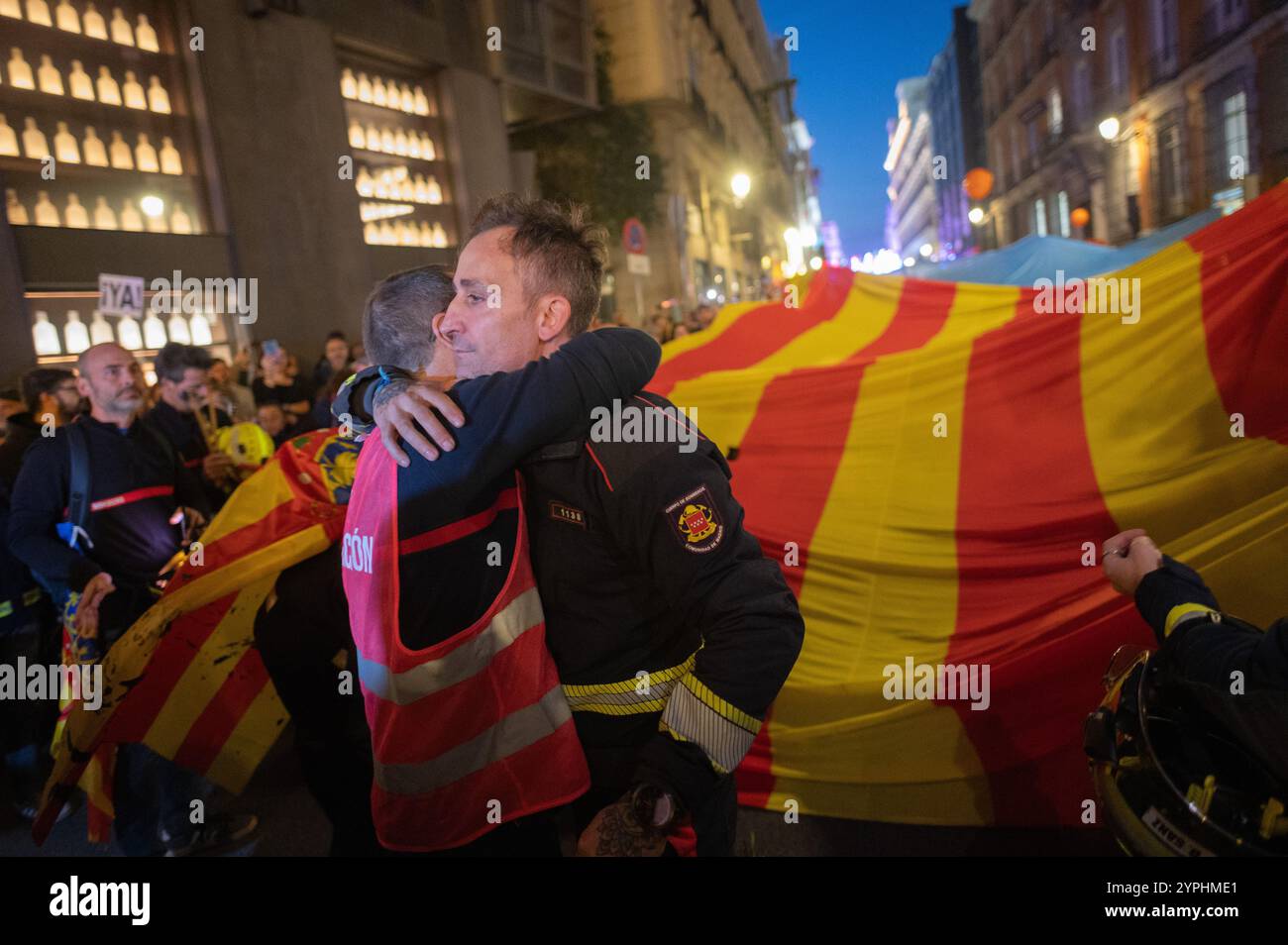 Madrid, Spain. 30th Nov, 2024. Firefighters hug while others carry a ...