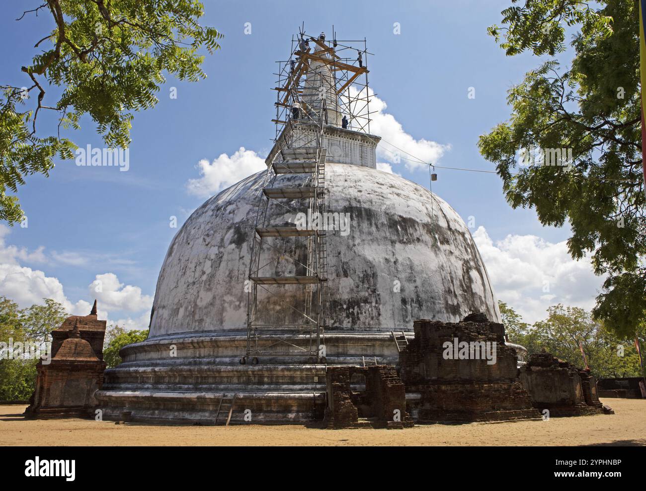 Sri Lankan workers at the Kiri Vehera stupa in the ruined city of ...
